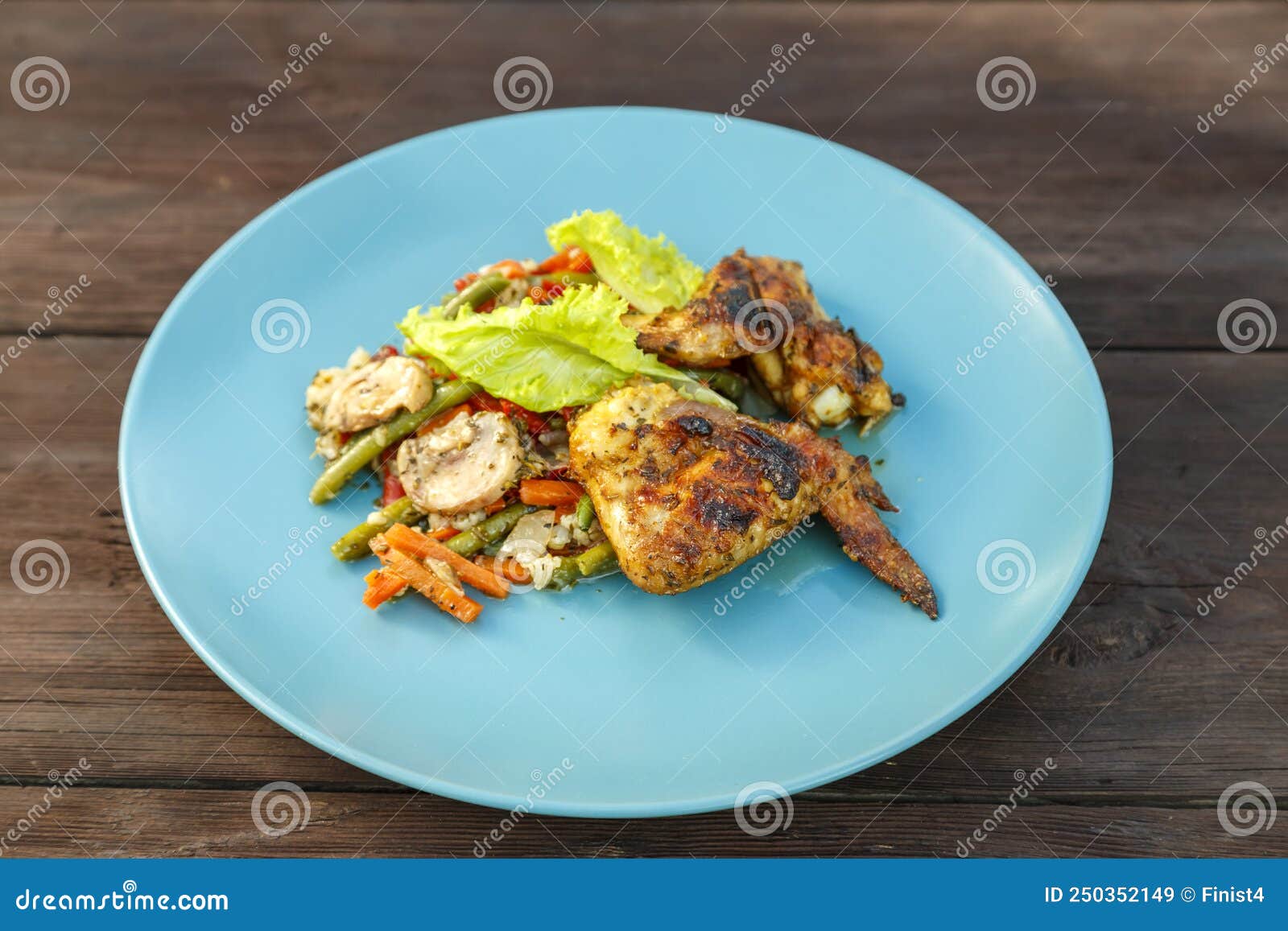 Blue Plate with Chicken and Vegetables on a Wooden Table. Stock Image ...