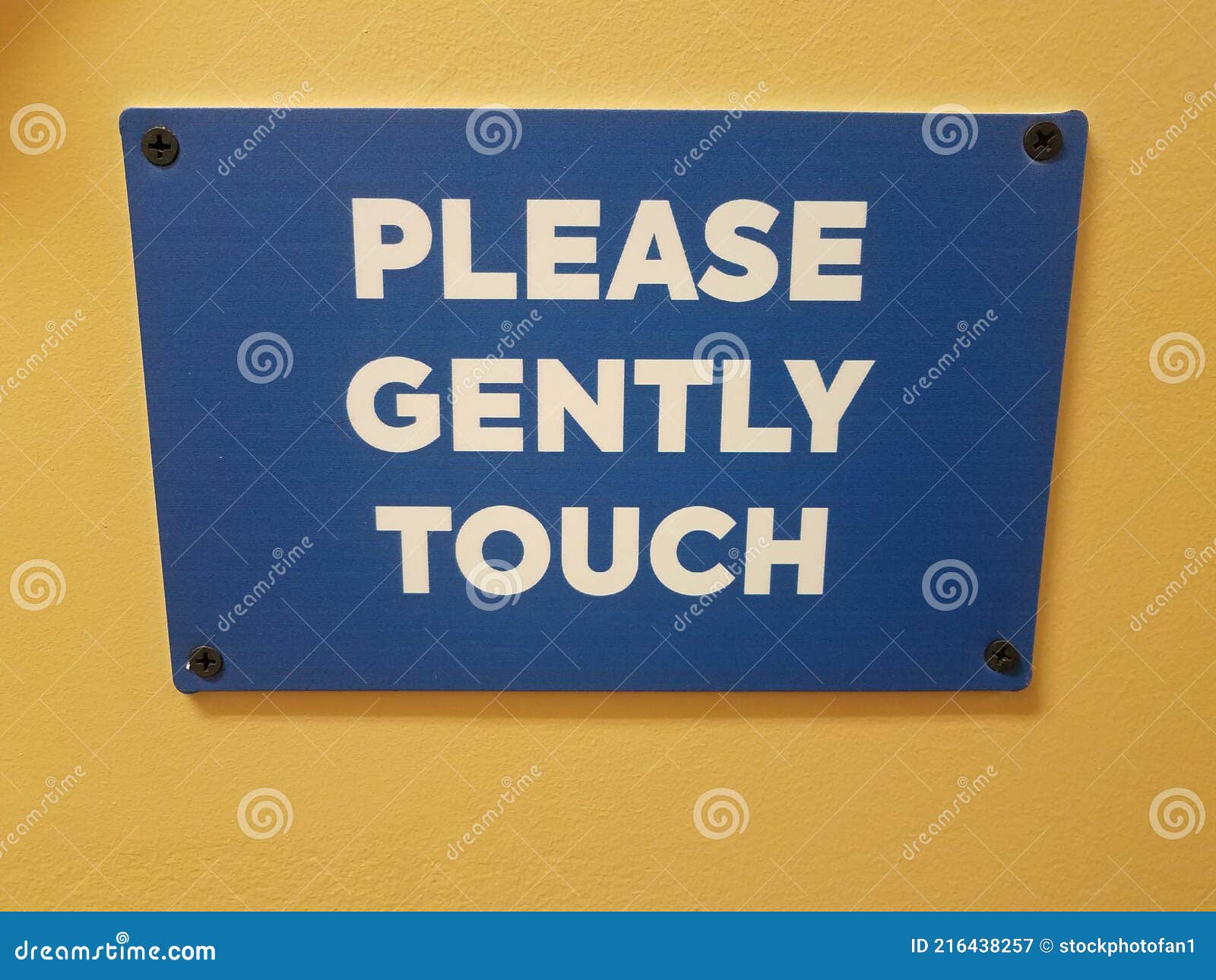 Blue Please Gently Touch Sign on Yellow Wall Stock Image - Image of ...