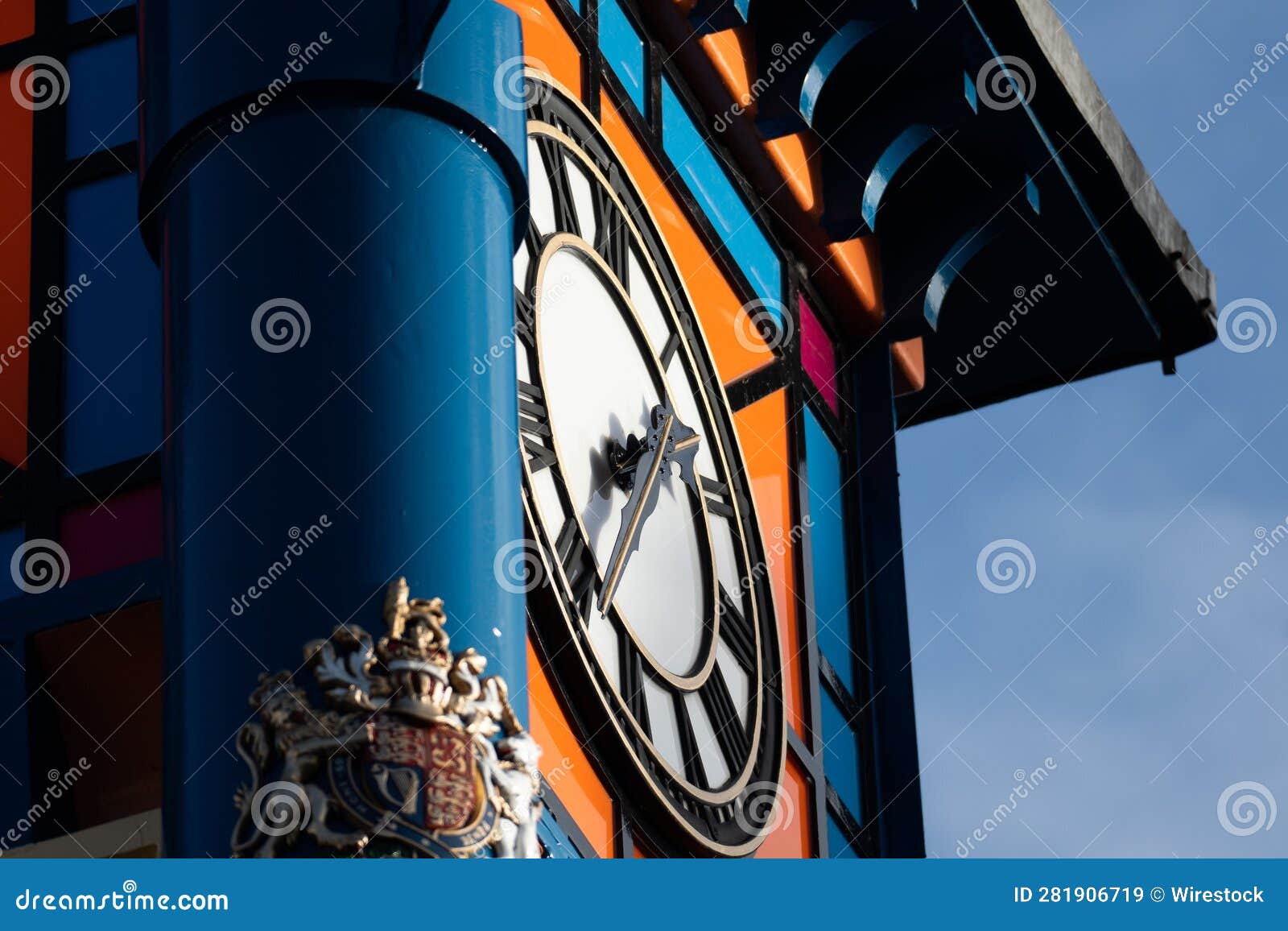 A Blue Pole with an Orange Clock Face on it S Side Stock Image - Image ...