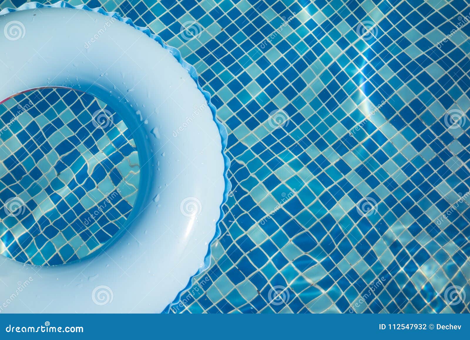Blue Pool Float, Ring Floating in a Refreshing Blue Swimming Pool Stock ...