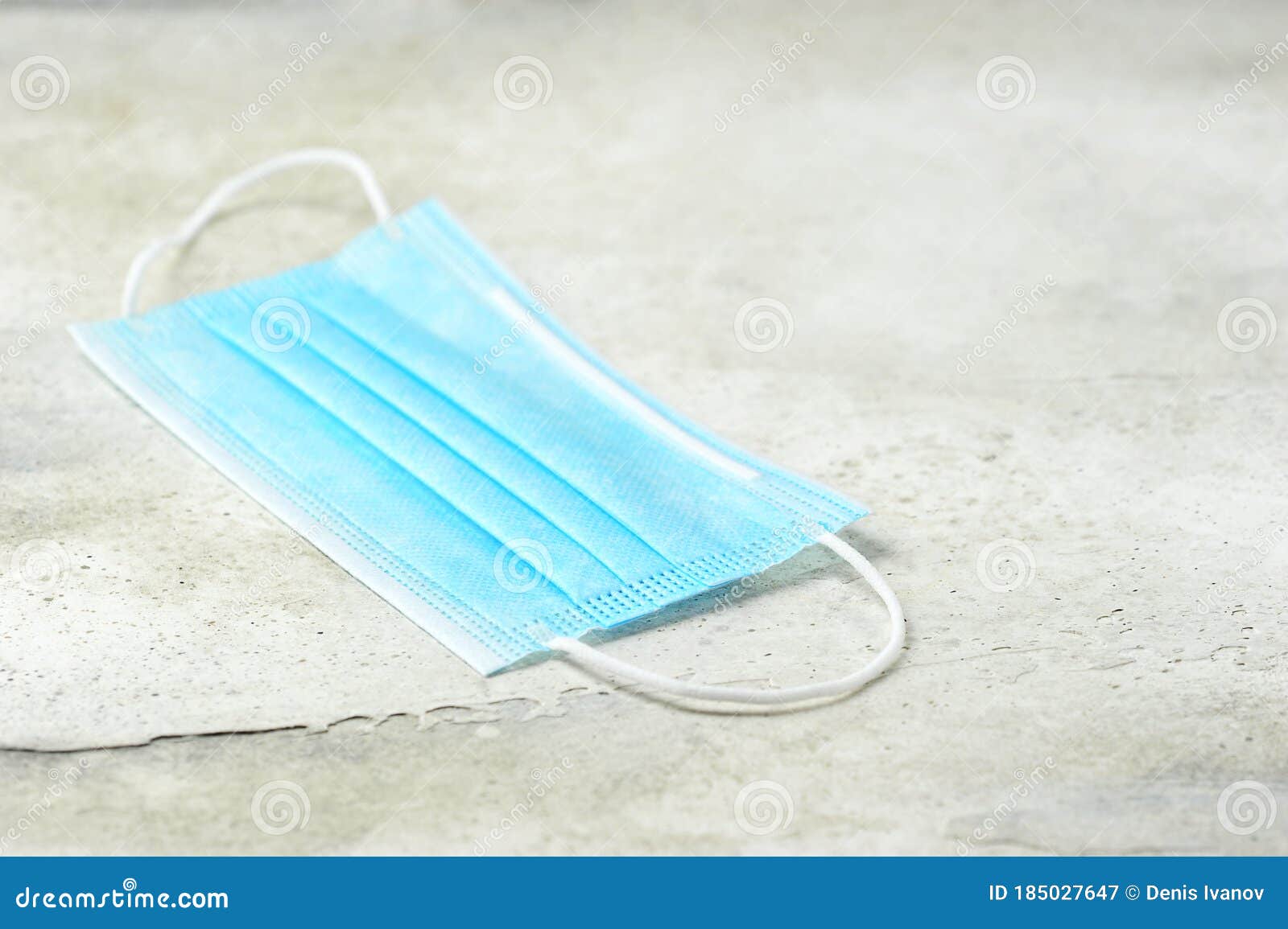 Blue Protective Mask on a Grey Concrete Background Stock Image - Image ...