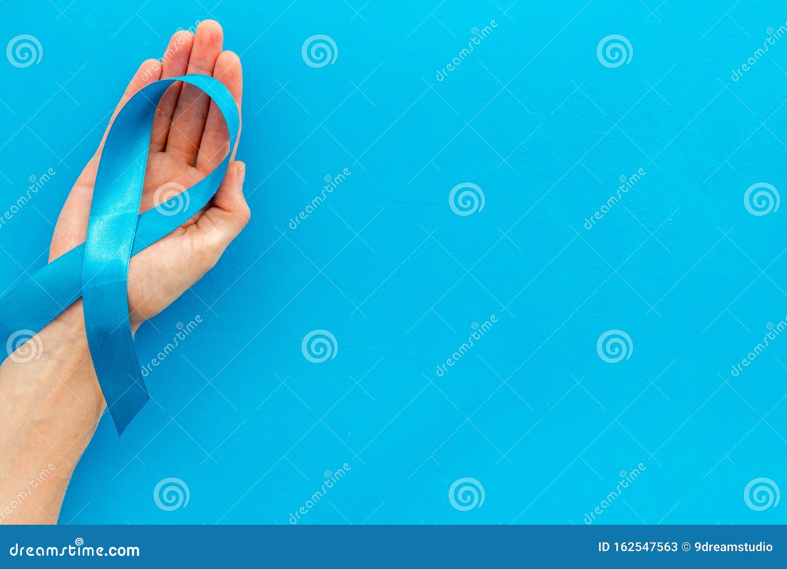 Blue Ribbon in Hands As Symbol Disease Control on Blue Background Top ...