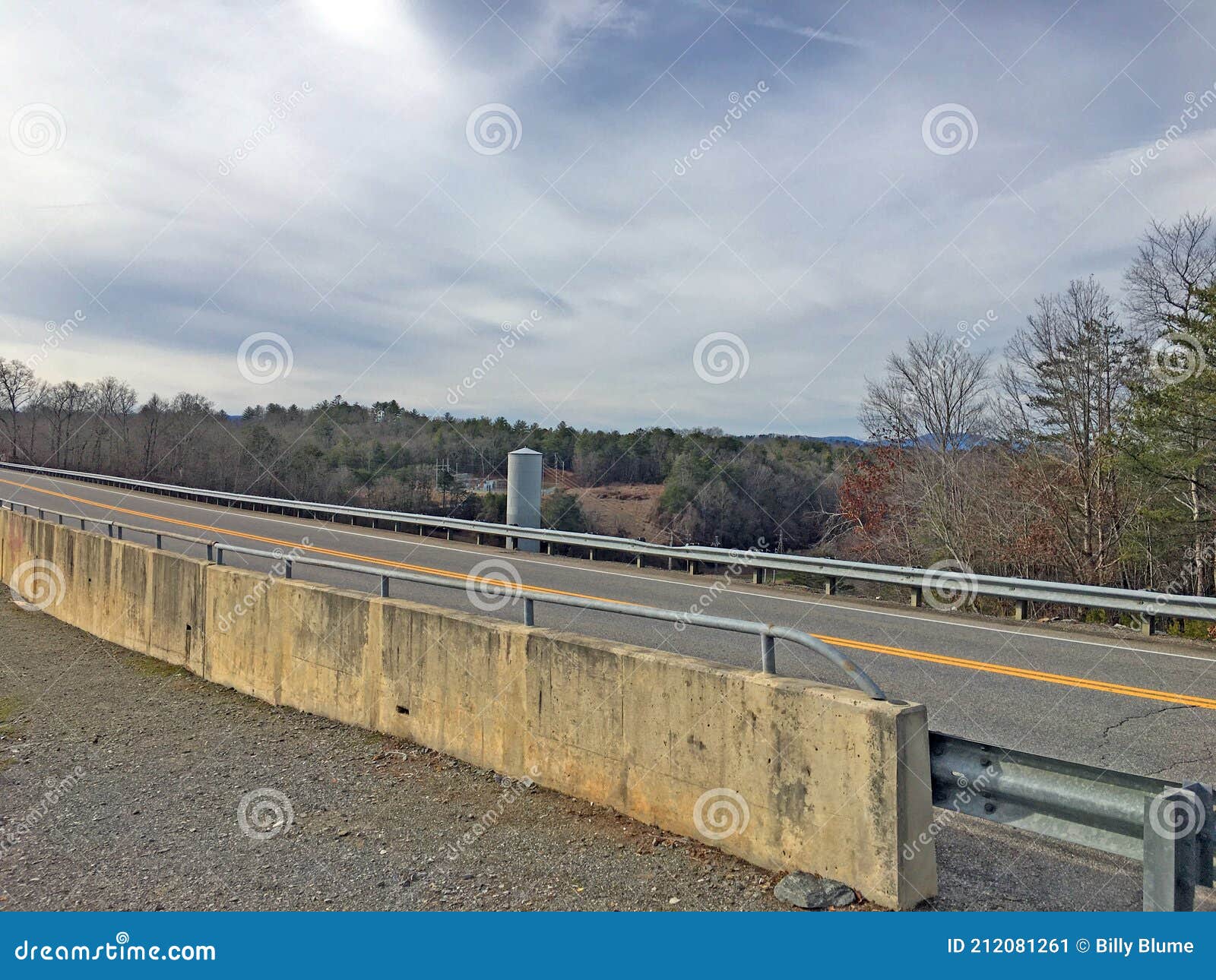 Blue Ridge Dam View of Tree Line and Highway Divider Wall Stock Image ...