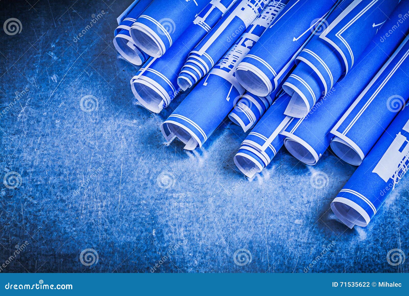 Blue Rolled Blueprints on Metallic Background Construction Conce Stock ...