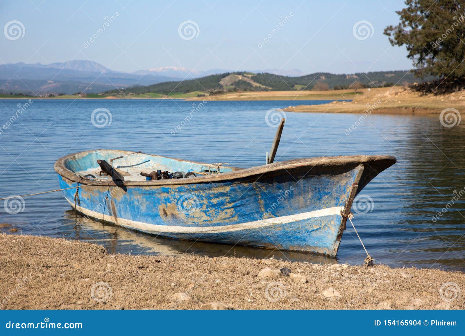 Blue rowing boat on lake stock photo. Image of lonely - 154165904