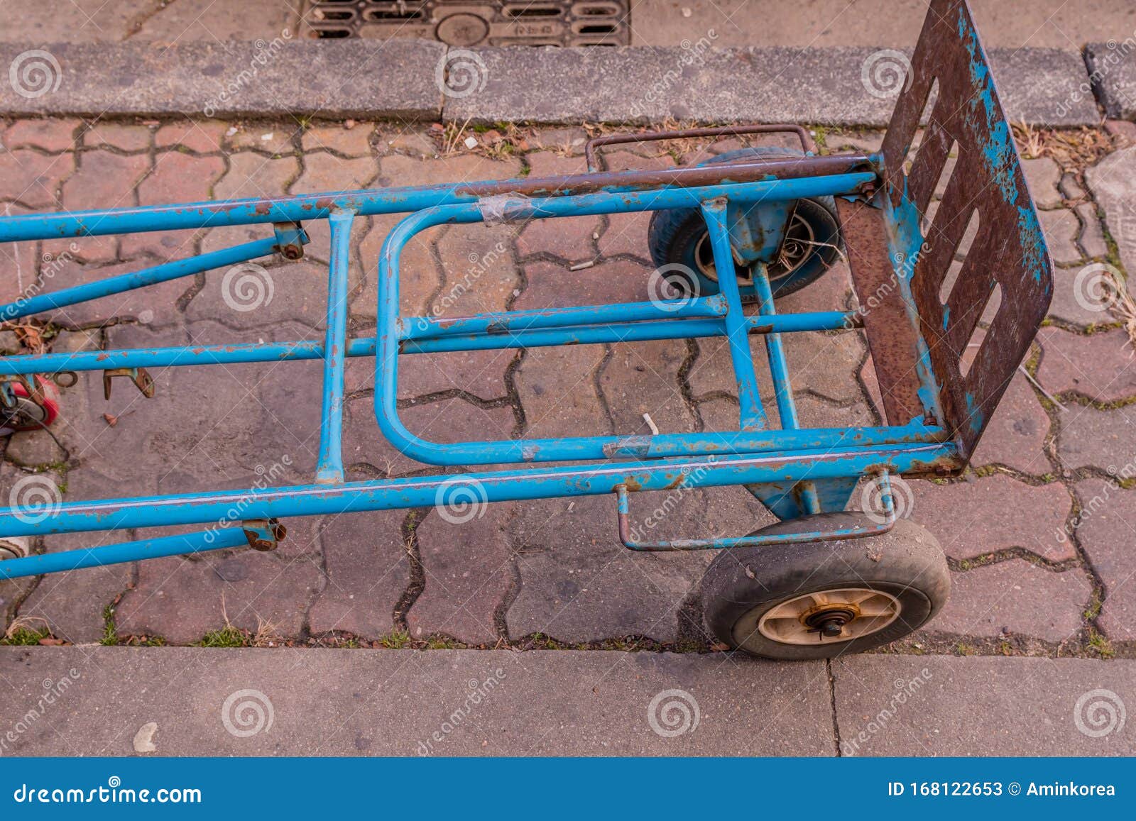 Blue Rusty Dolly on Sidewalk Stock Image - Image of laying, rust: 168122653