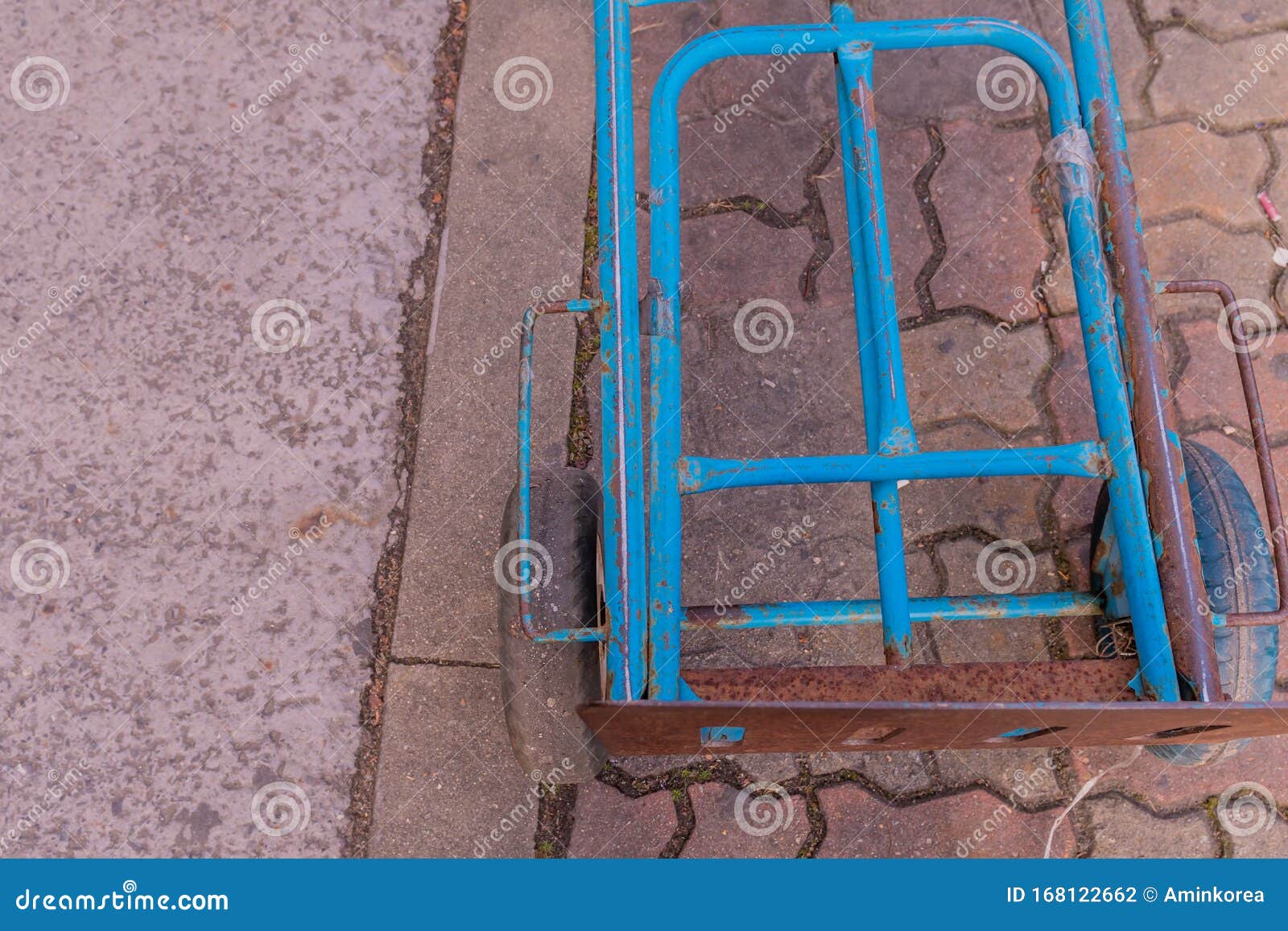 Blue Rusty Dolly on Sidewalk Stock Photo - Image of logistics, brick ...