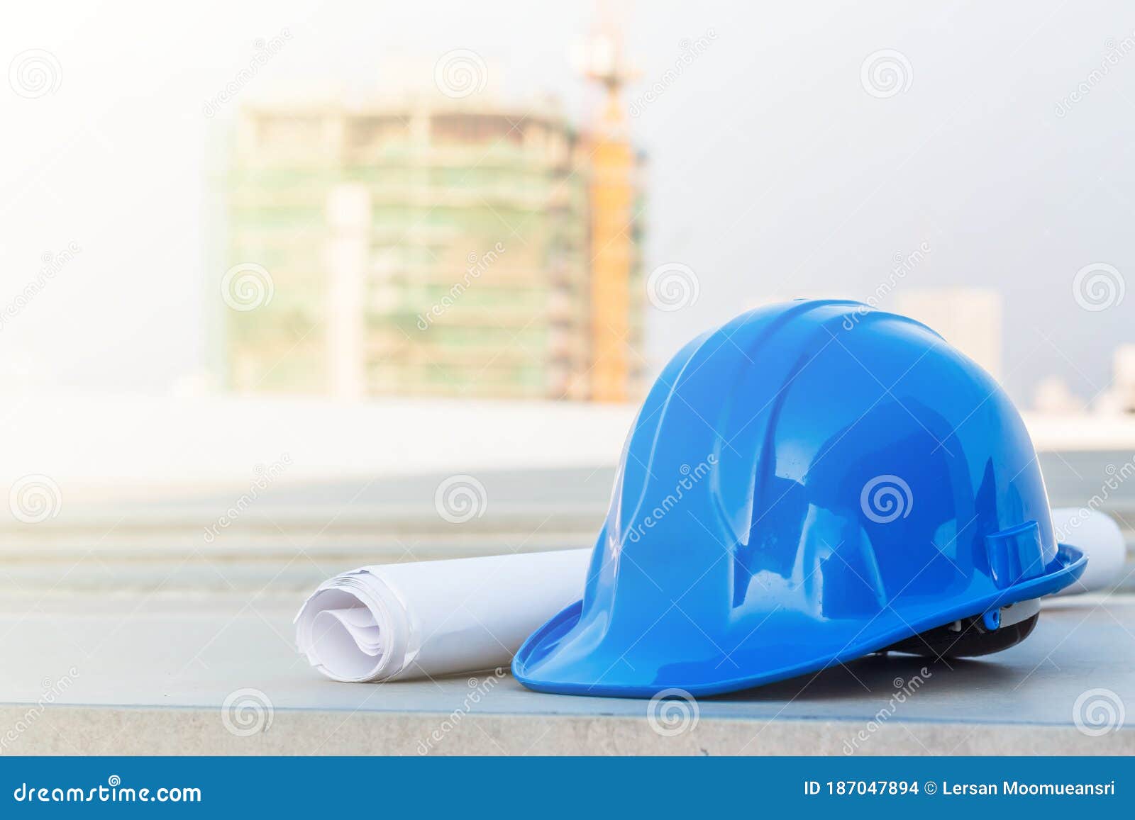 The Blue Safety Helmet and the Blueprint at Construction Site with ...