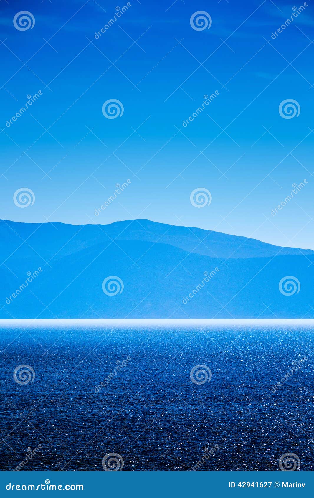 Blue Sea and Sky with Distant Mountains Stock Image - Image of beauty ...