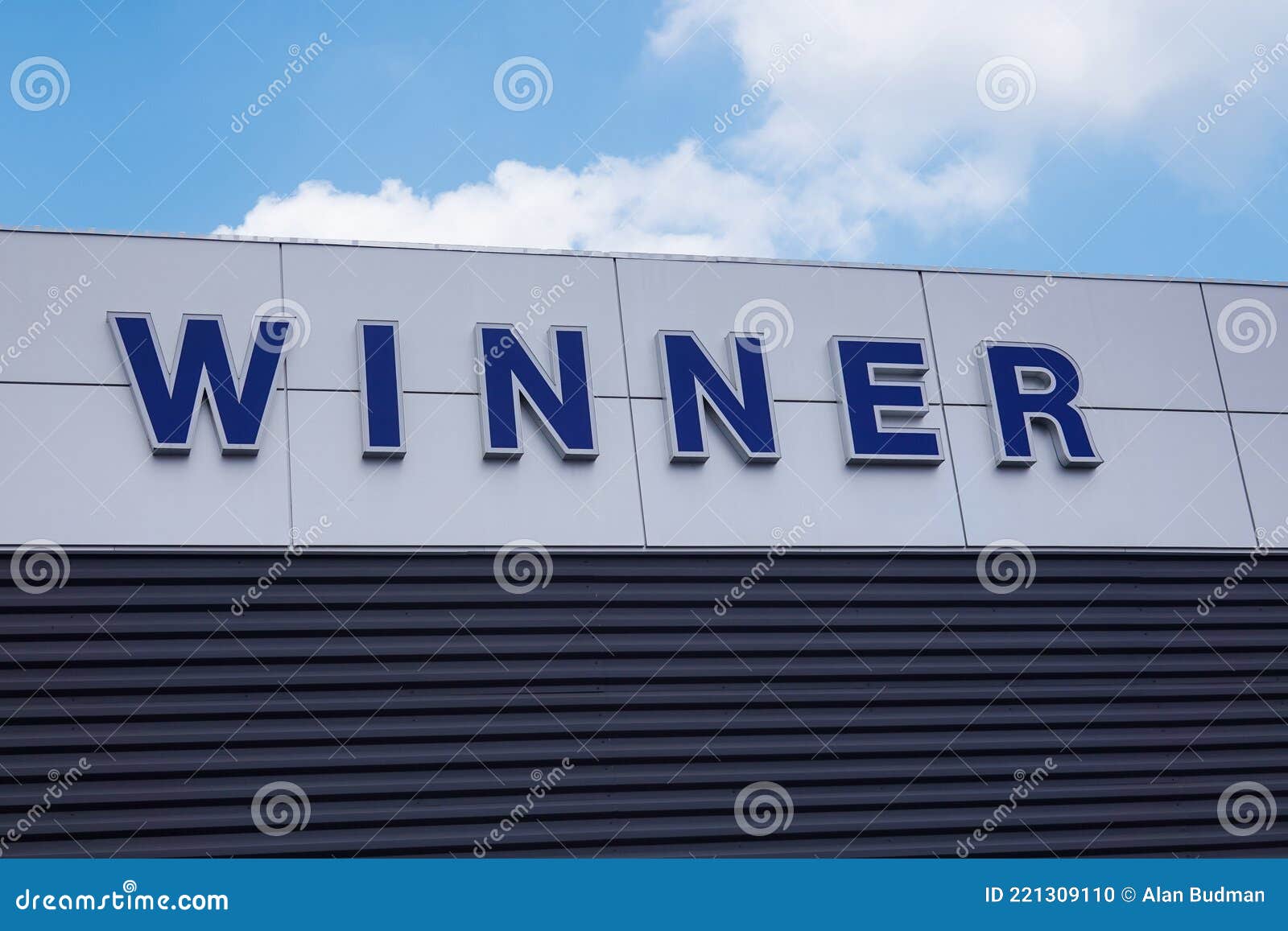 Blue Sign on the Wall of a Building that Says Winner in Blue Letters ...