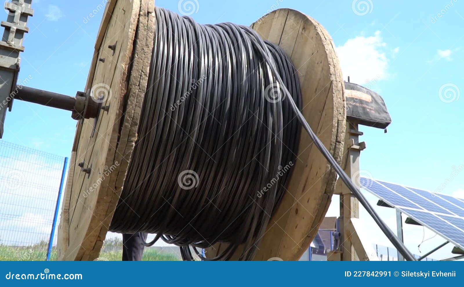 Unwinding of a Massive Spool of Cable at a Construction Site, Laying ...