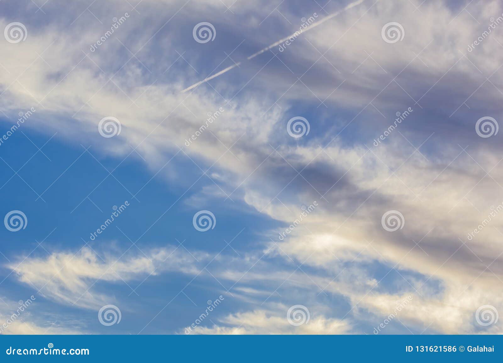 Blue Sky with Cirrus Clouds and Contrails at Sunset Stock Photo - Image ...