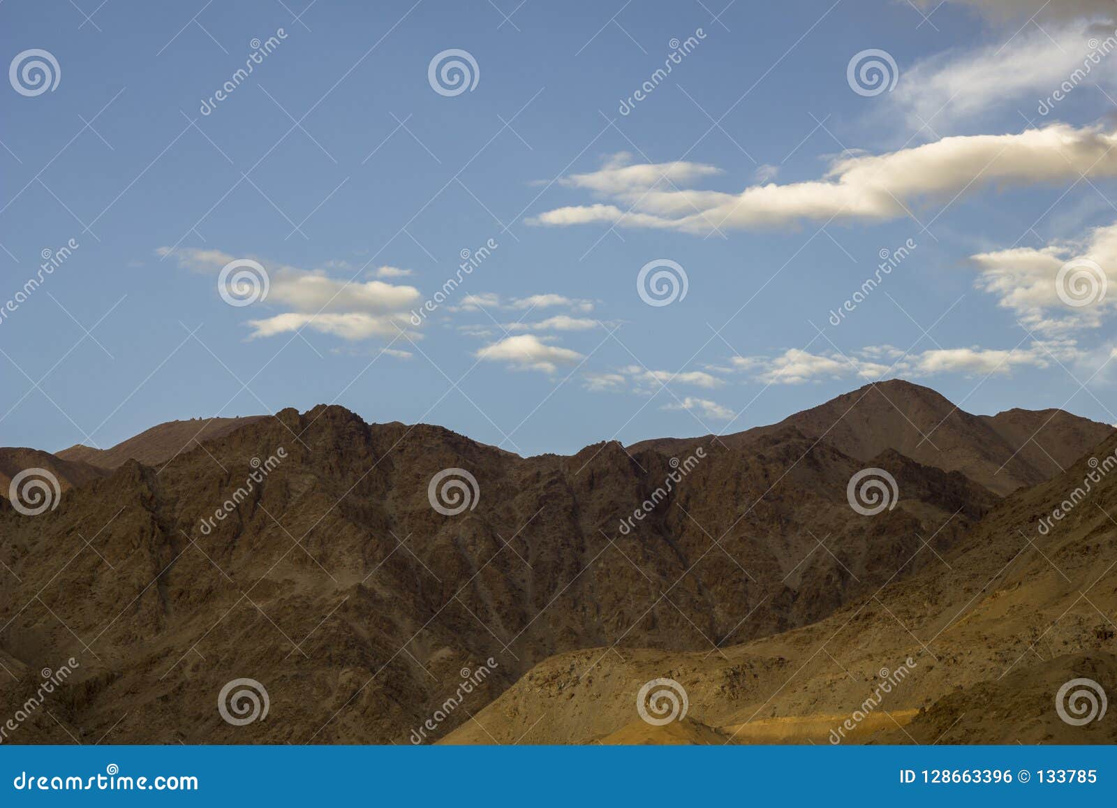 Blue Sky with Clouds Over the Sandy Mountains Stock Photo - Image of ...