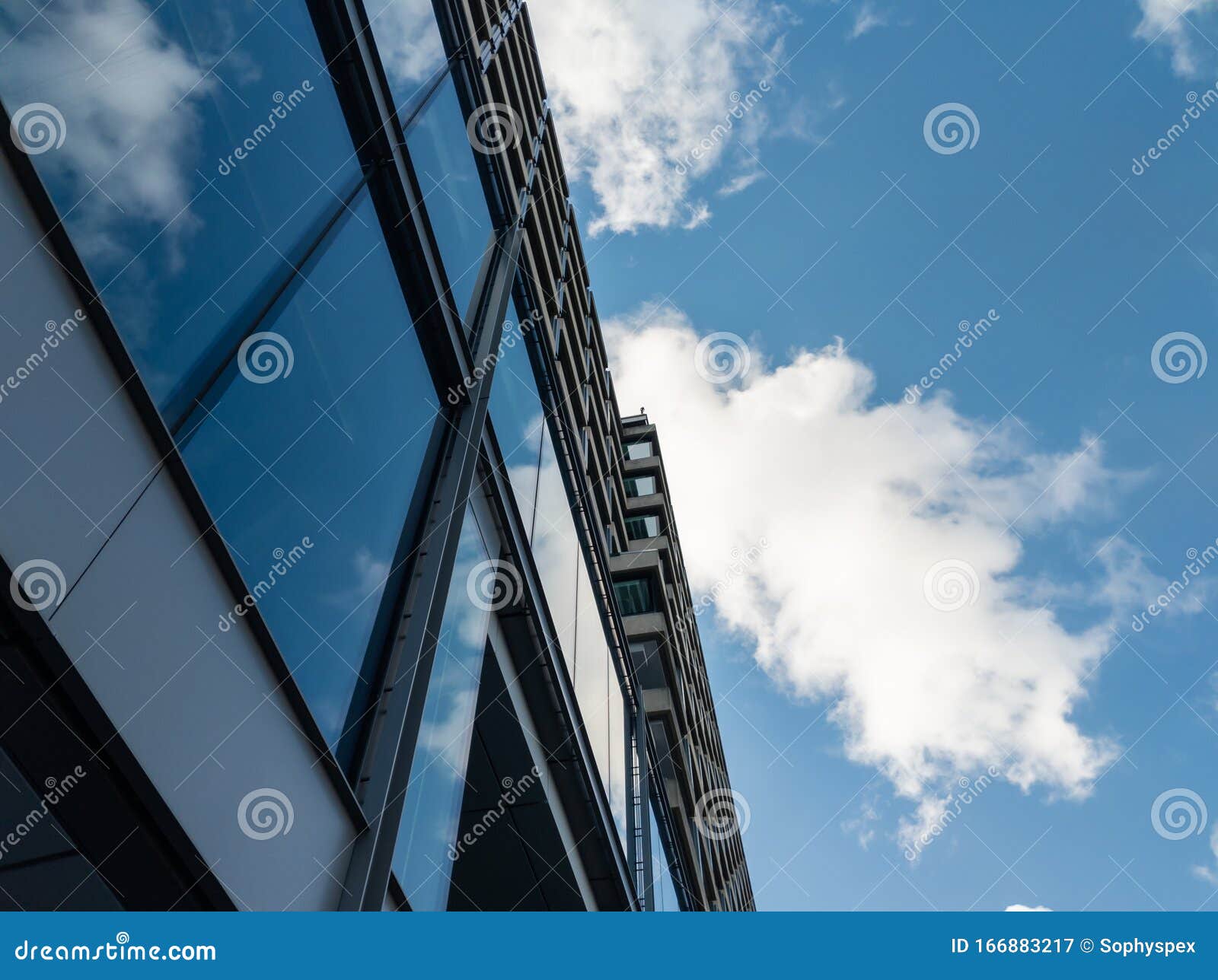 Looking Up at Modern Glass Building with Blue Sky and Clouds Stock ...