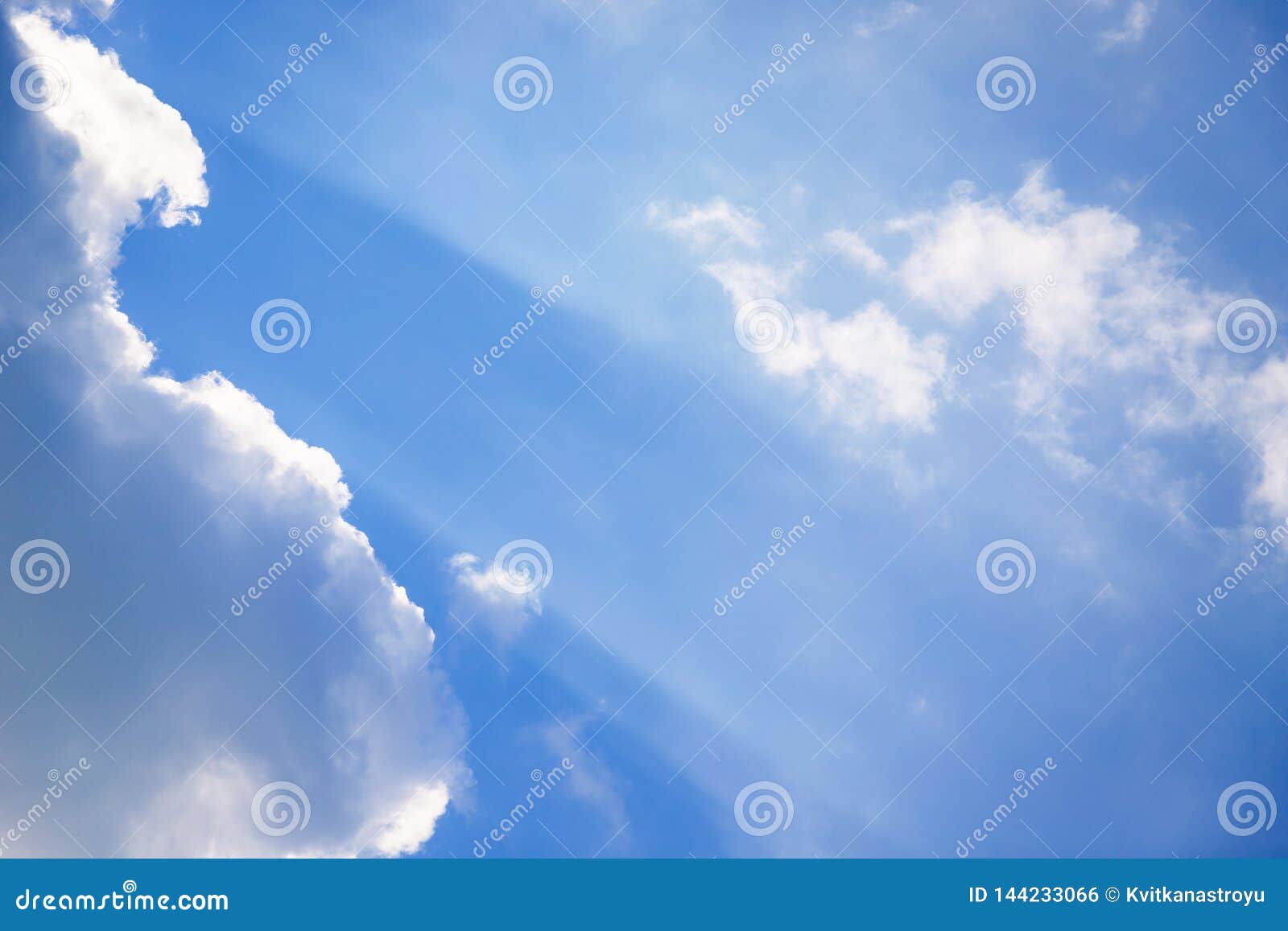 Blue Sky with Sun Rays. Beam of Light and the Fluffy Clouds Stock Photo ...