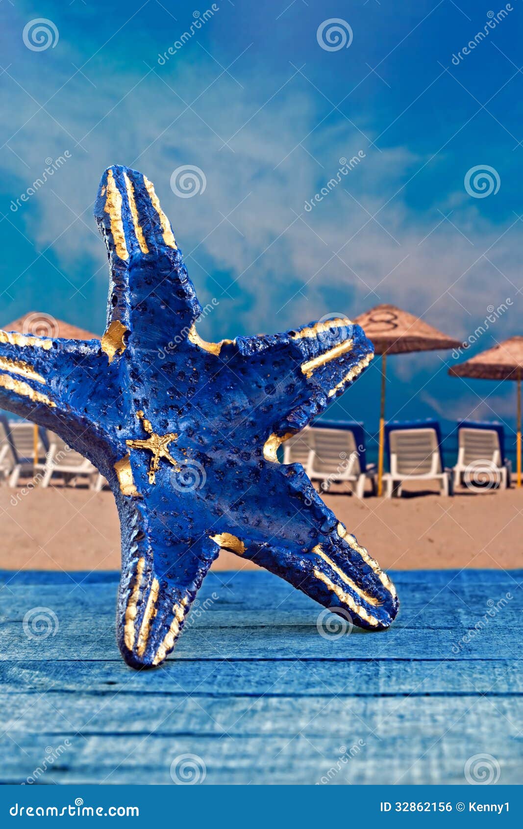 Blue Starfish Shape Against Parasols on Beach Stock Photo - Image of ...