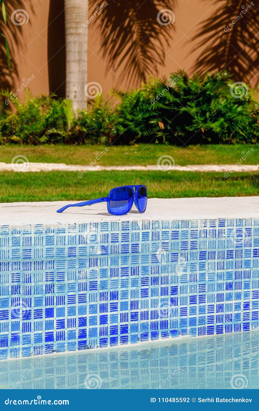 Blue Sunglasses on the Side of the Pool Stock Photo - Image of modern ...