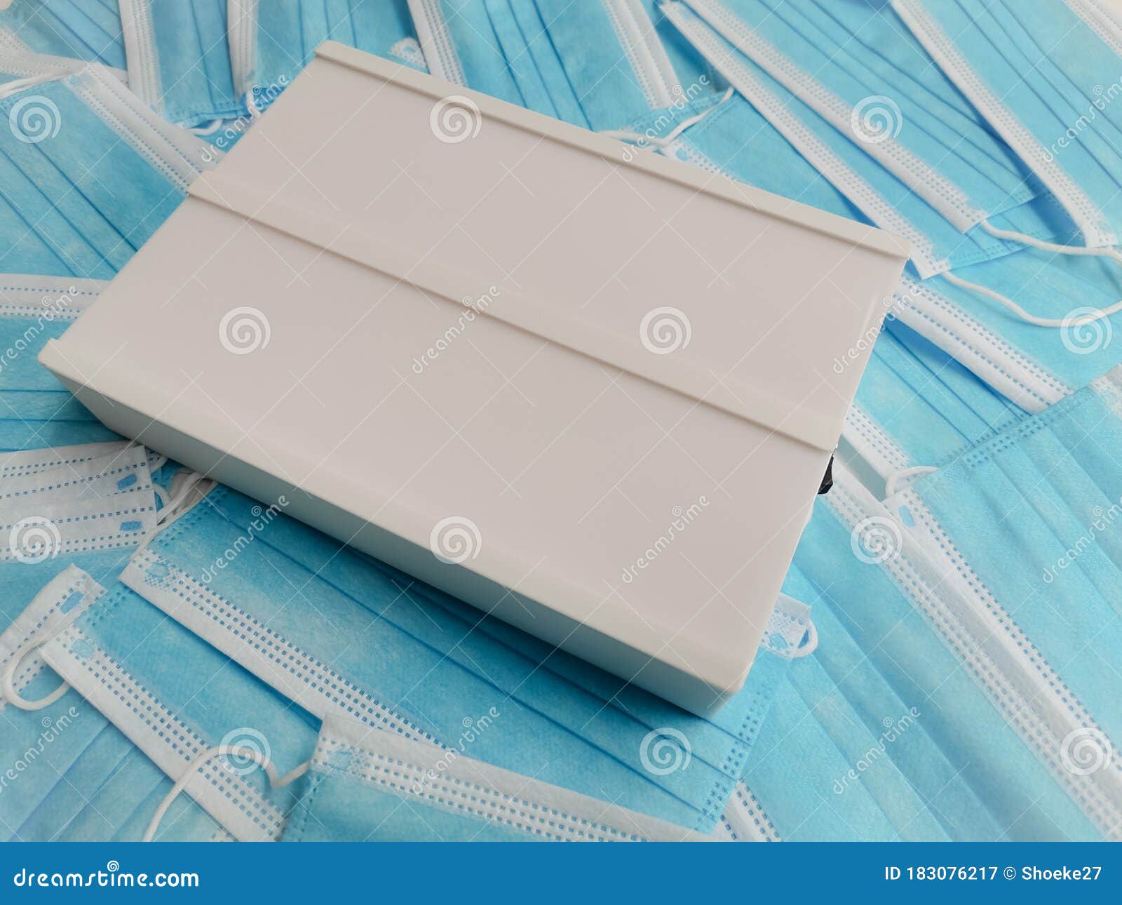 Blue Surgical Face Masks with an Empty White Light Box Stock Image ...