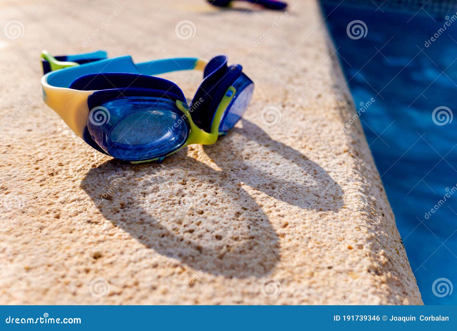 Blue Swimming Pool Goggles Illuminated by the Summer Sun on the Edge of ...
