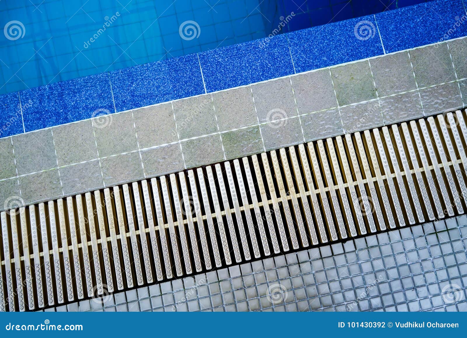 Blue Swimming Pool with Grating between Grey Tile and Mosaic Flo Stock ...