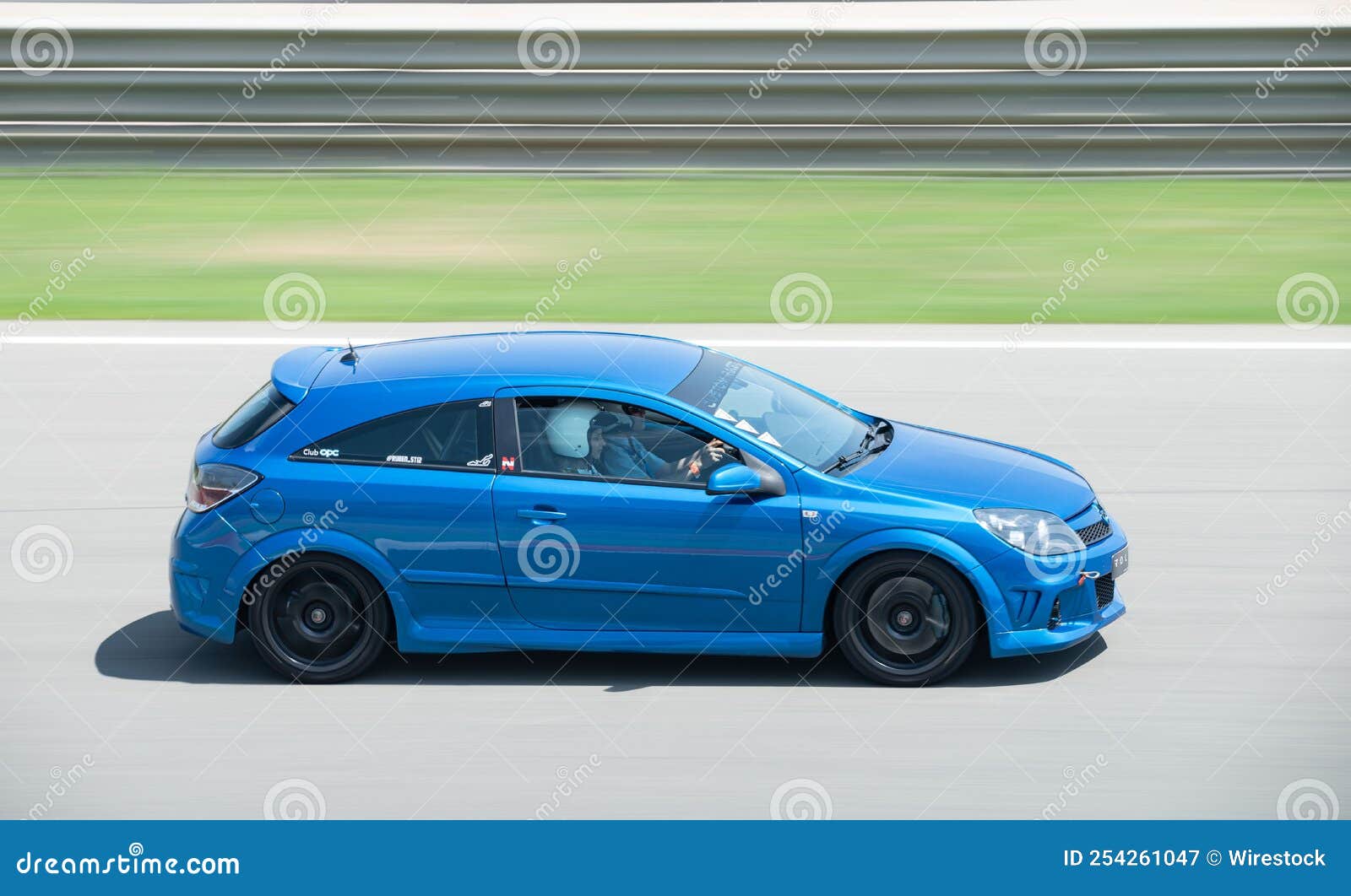 Blue Third Generation Opel Astra OPC Running on the Race Track ...