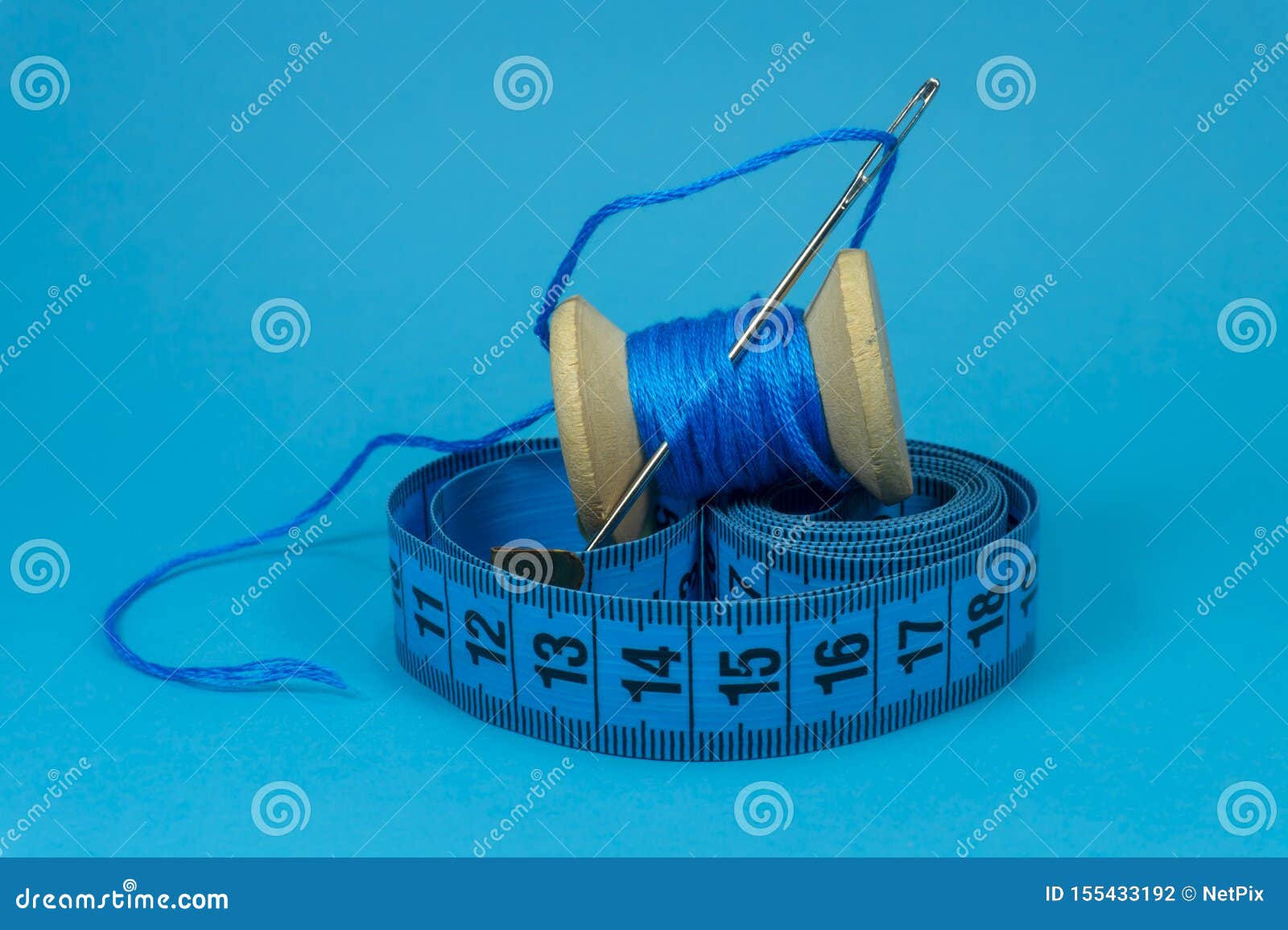 Blue Thread, Tape Measure and Sewing Needle Stock Photo - Image of ...