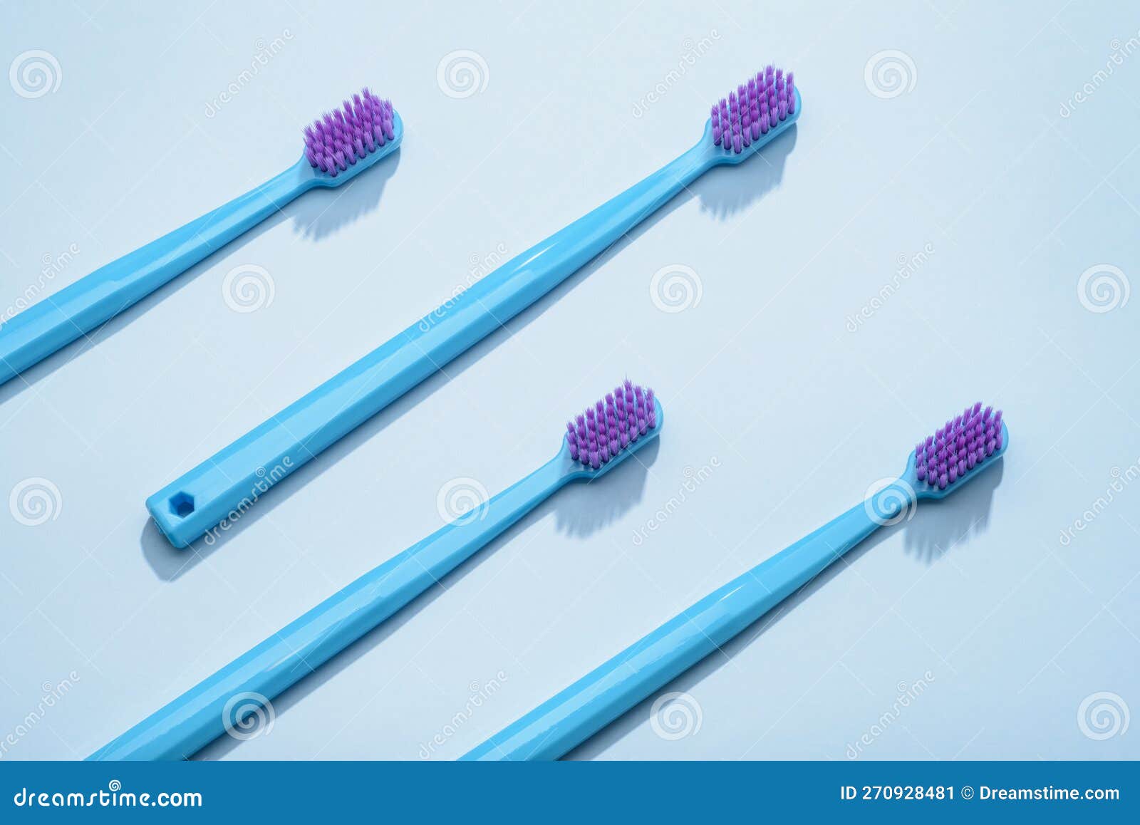 Blue Toothbrushes, Green and Yellow on a Blue Background Stock Image ...