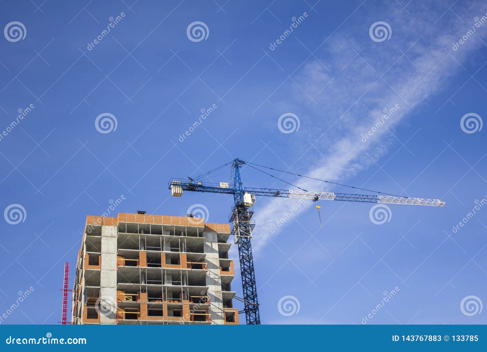 Blue Tower Crane Near a Tall Building Under Construction on the ...