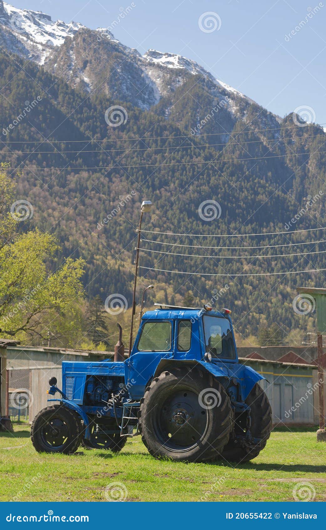 Blue Tractor in the Background of the Mountains Stock Photo - Image of ...