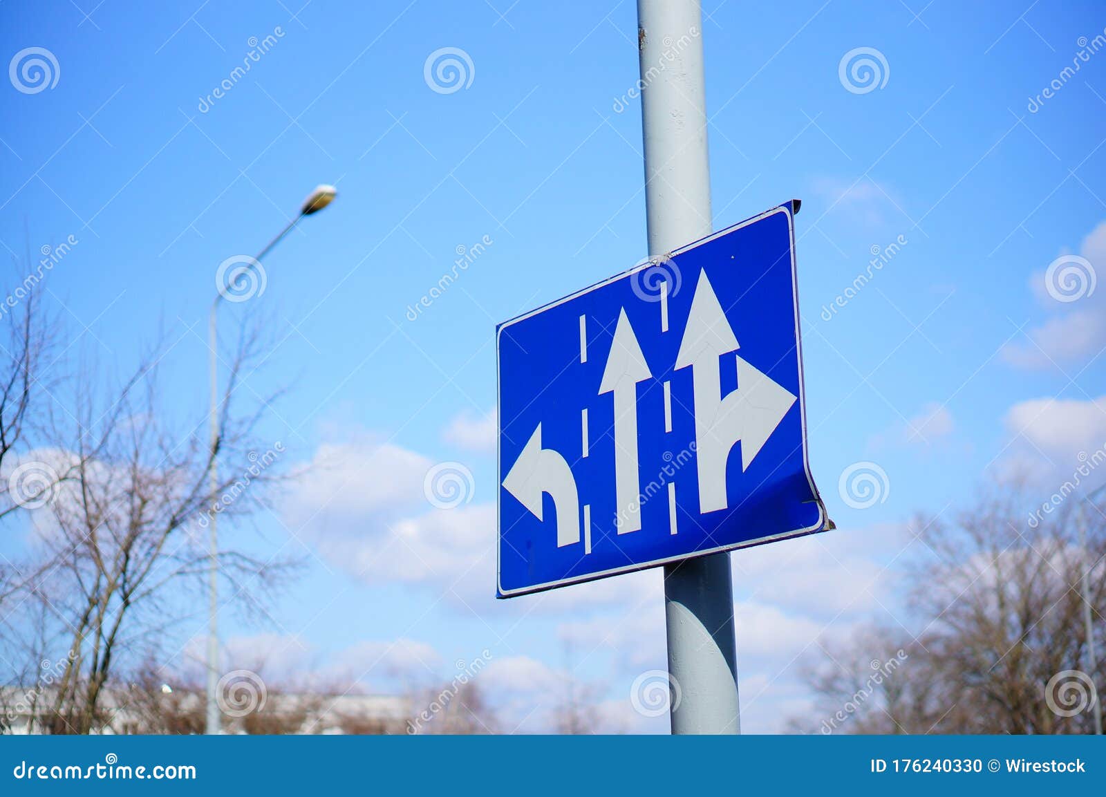Blue Traffic Sign with Arrows on a Pole Stock Photo - Image of ...