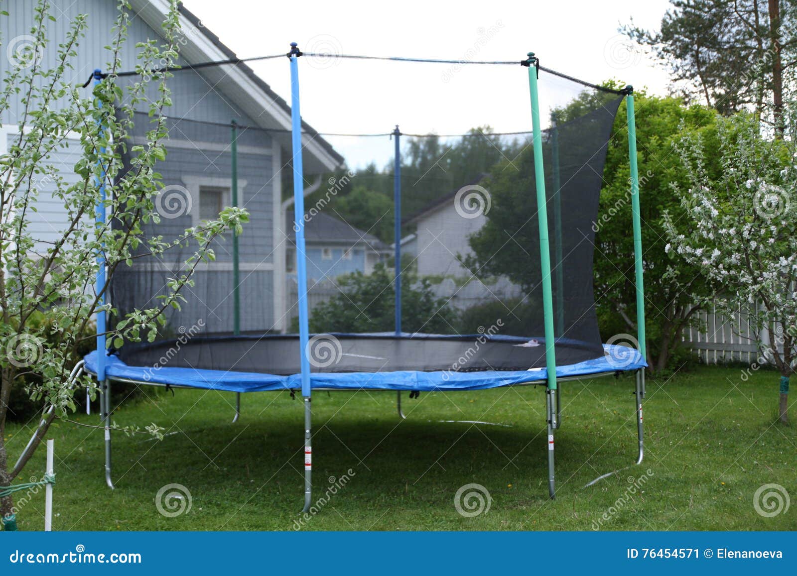 Blue Trampoline on the Lawn in Garden Stock Image - Image of caucasian ...