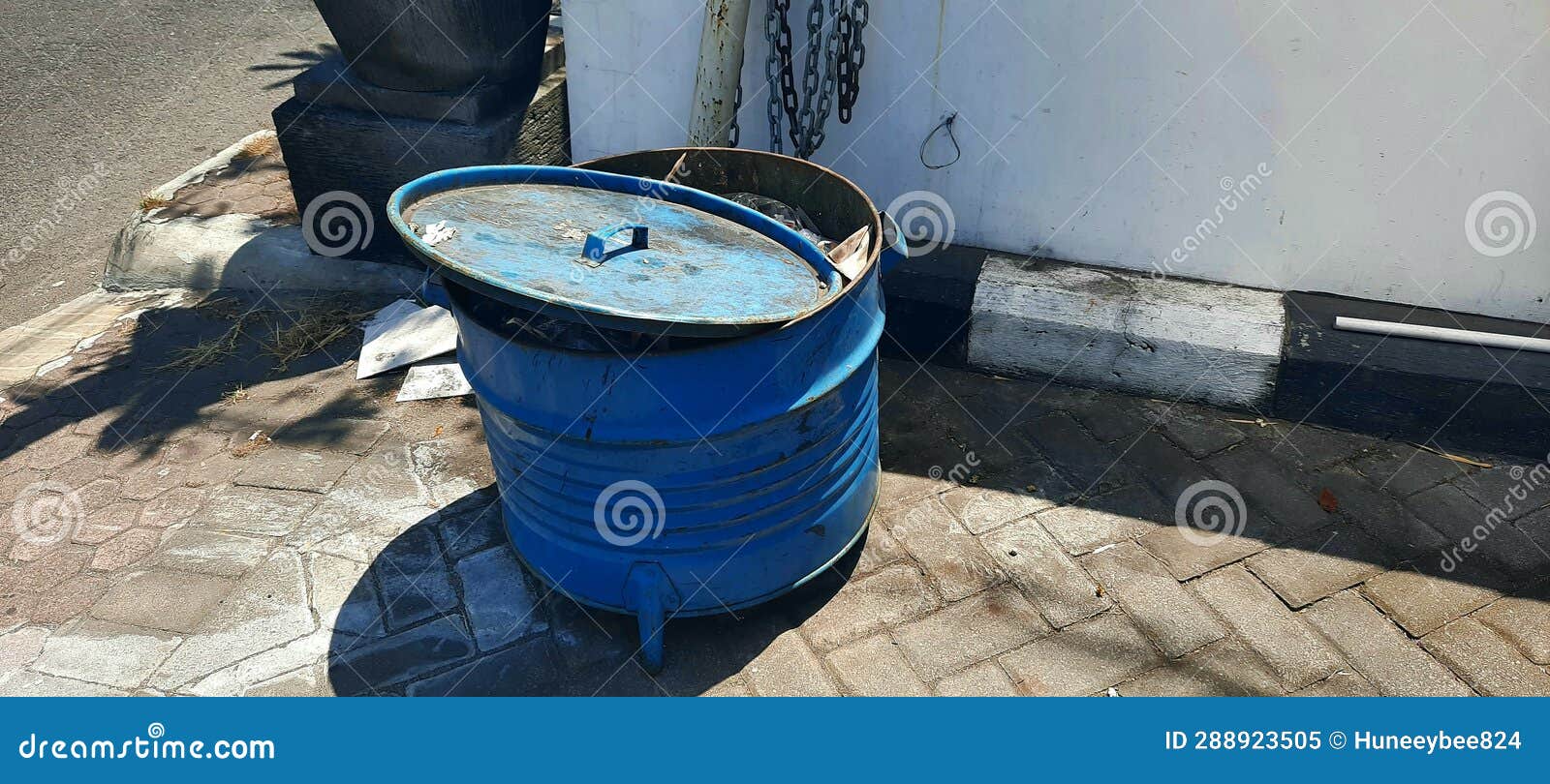 Blue Trash Can with a Half-open Lid Located in the Yard Stock Image ...