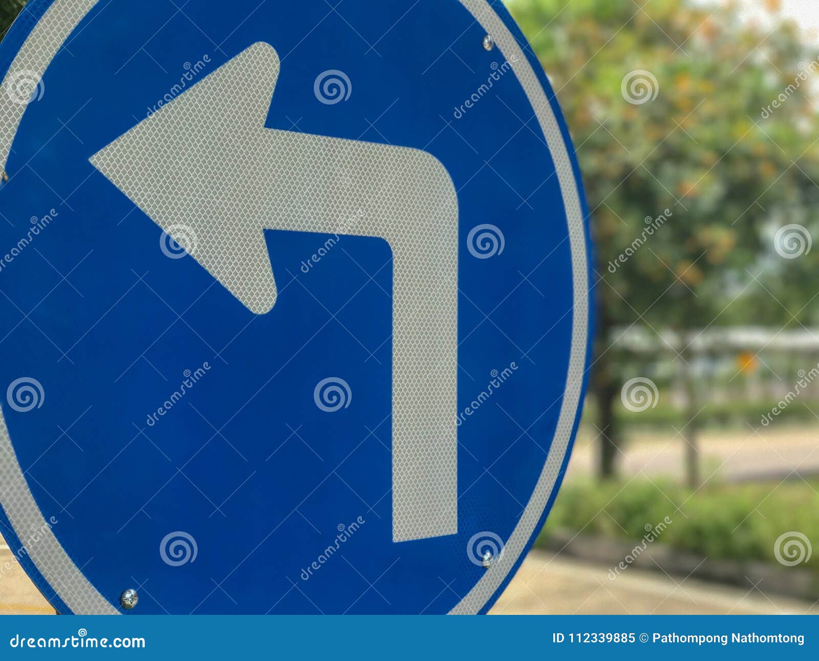 Blue Turn Left Sign on Pole Stock Image - Image of park, directional ...