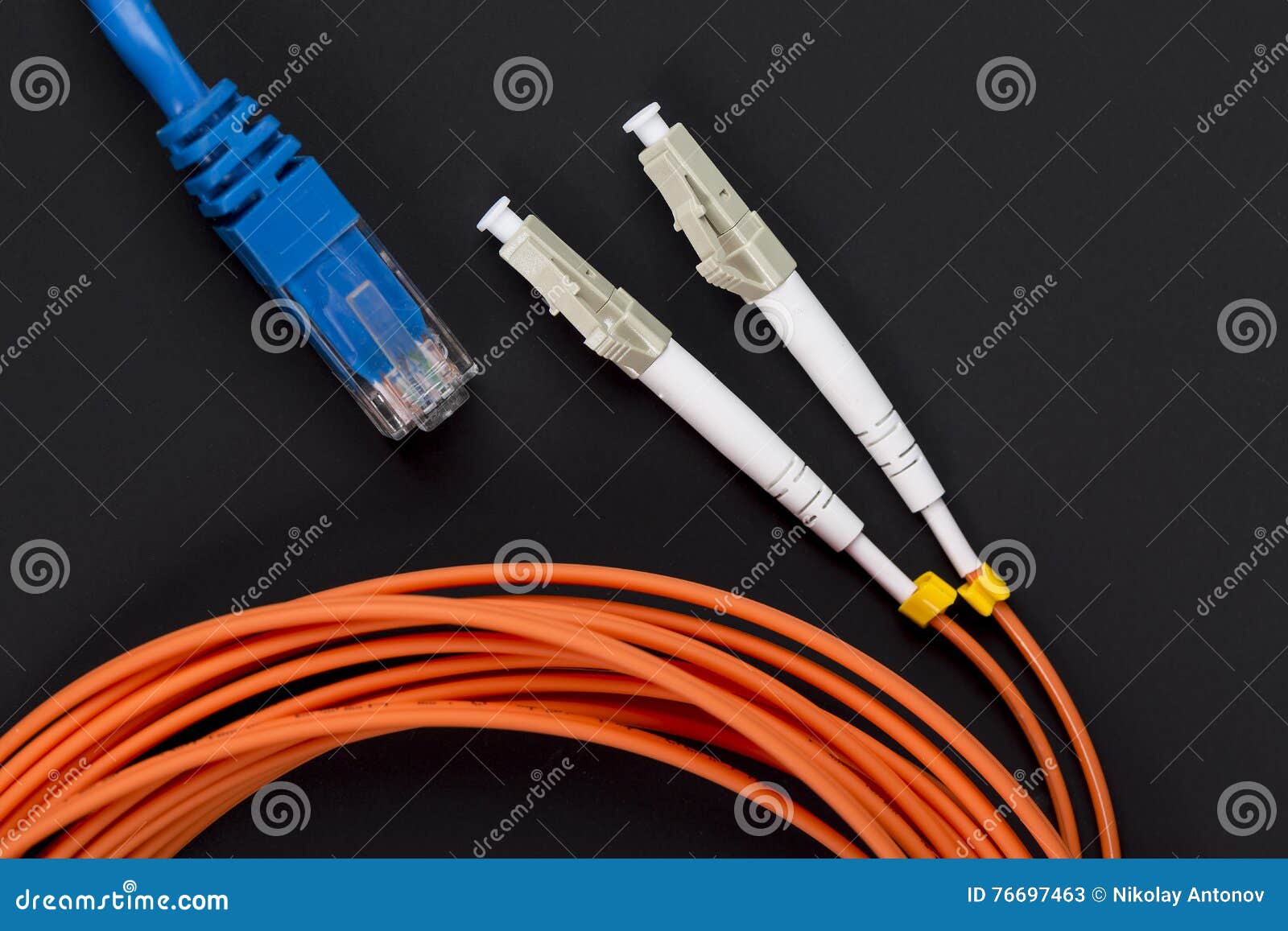 Blue Twisted Pair Patch Cord with Fiber Optics Orange Cable on Dark ...