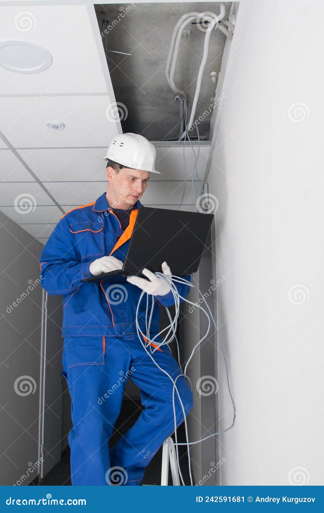 A Blue-uniformed Master Wiring a WiFi Router in a Hidden False Ceiling ...