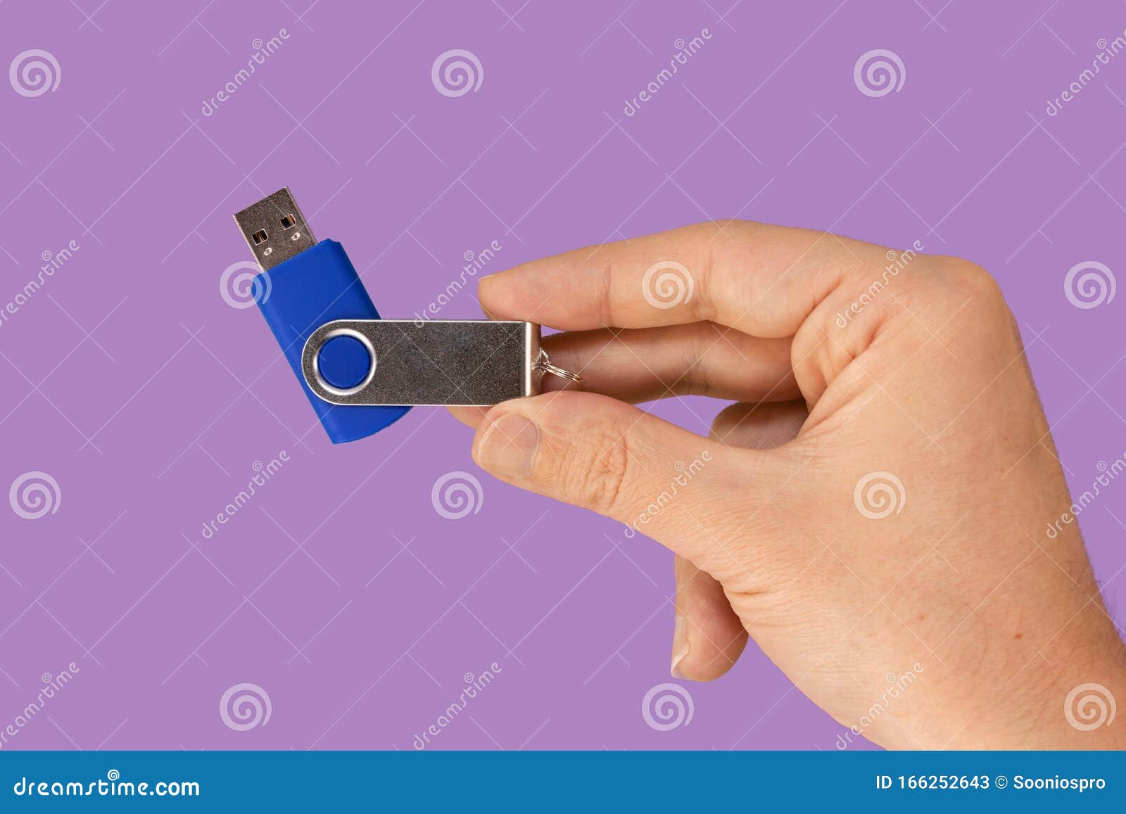 Blue USB Flash Memory on Hand with Isolated Violet Background Stock ...