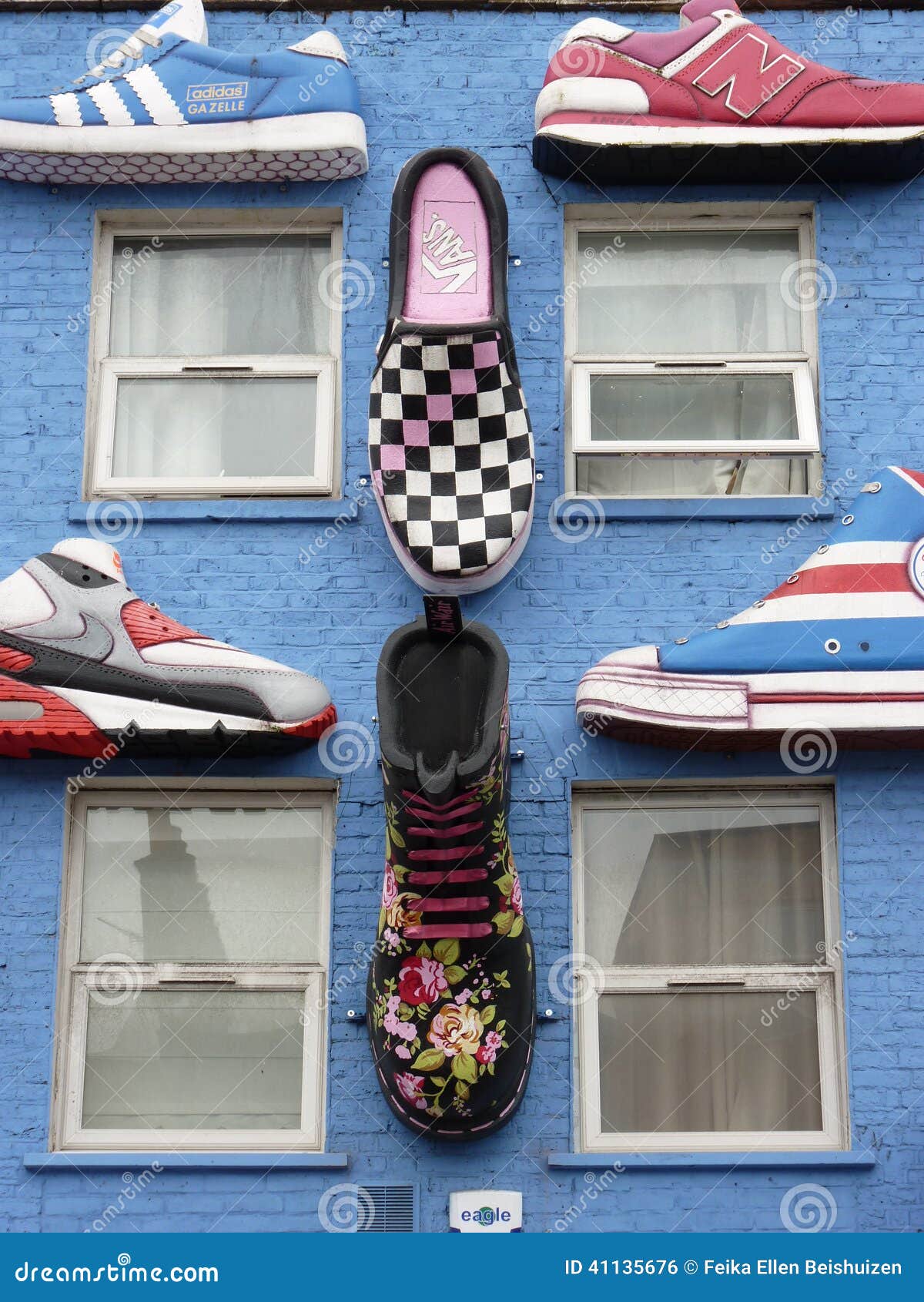 A Blue Wall with Loads of Shoes Editorial Photo - Image of wall ...