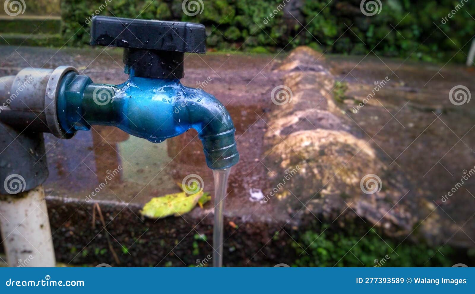 The Blue Water Faucet on the Side of the Road is Flowing Stock Image ...