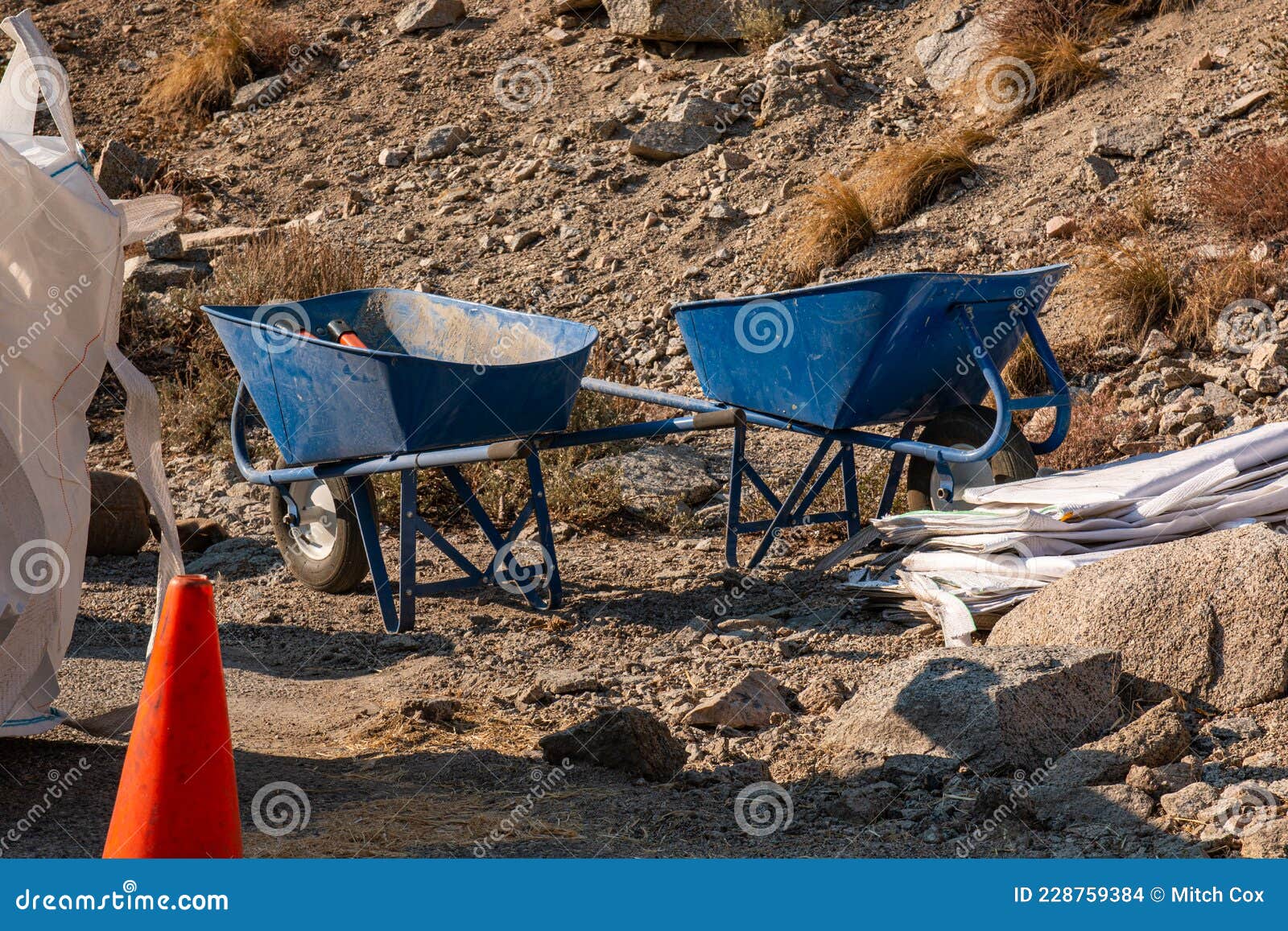 Blue Wheelbarrows stock photo. Image of maintenance - 228759384