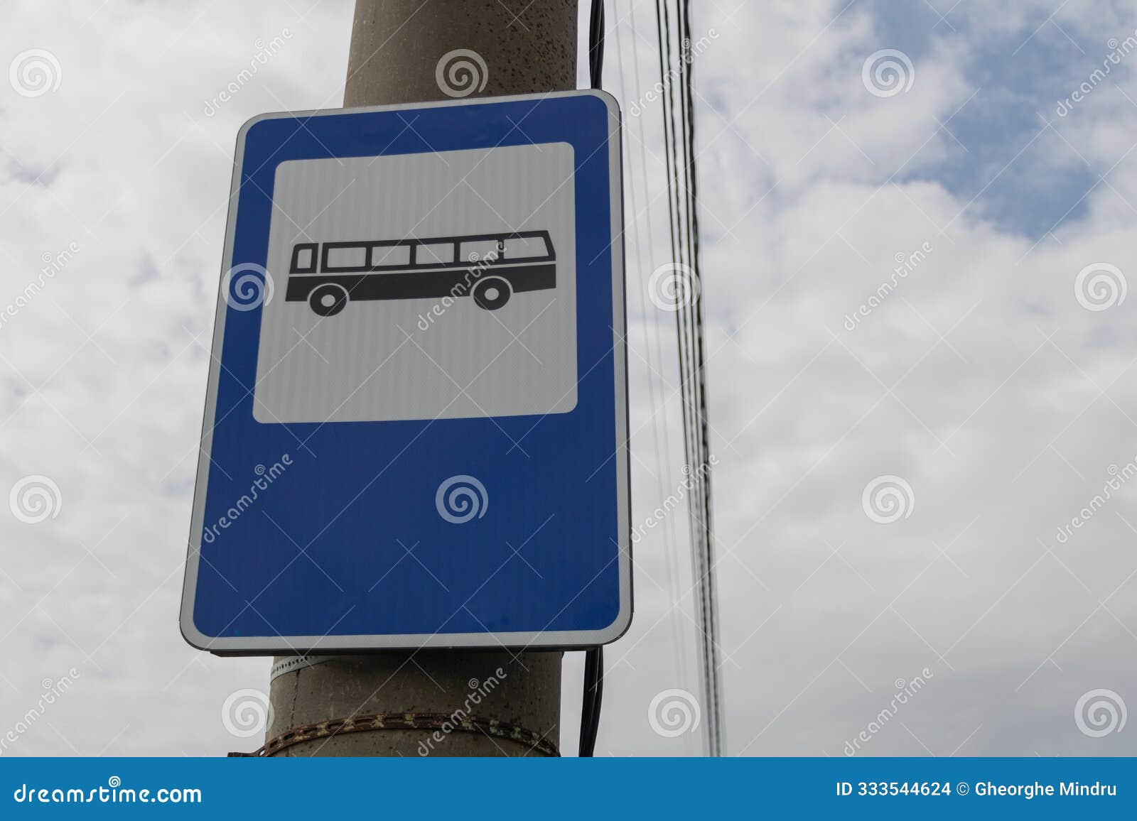 A Blue and White Bus Stop Sign with an Icon of Public Transportation on ...