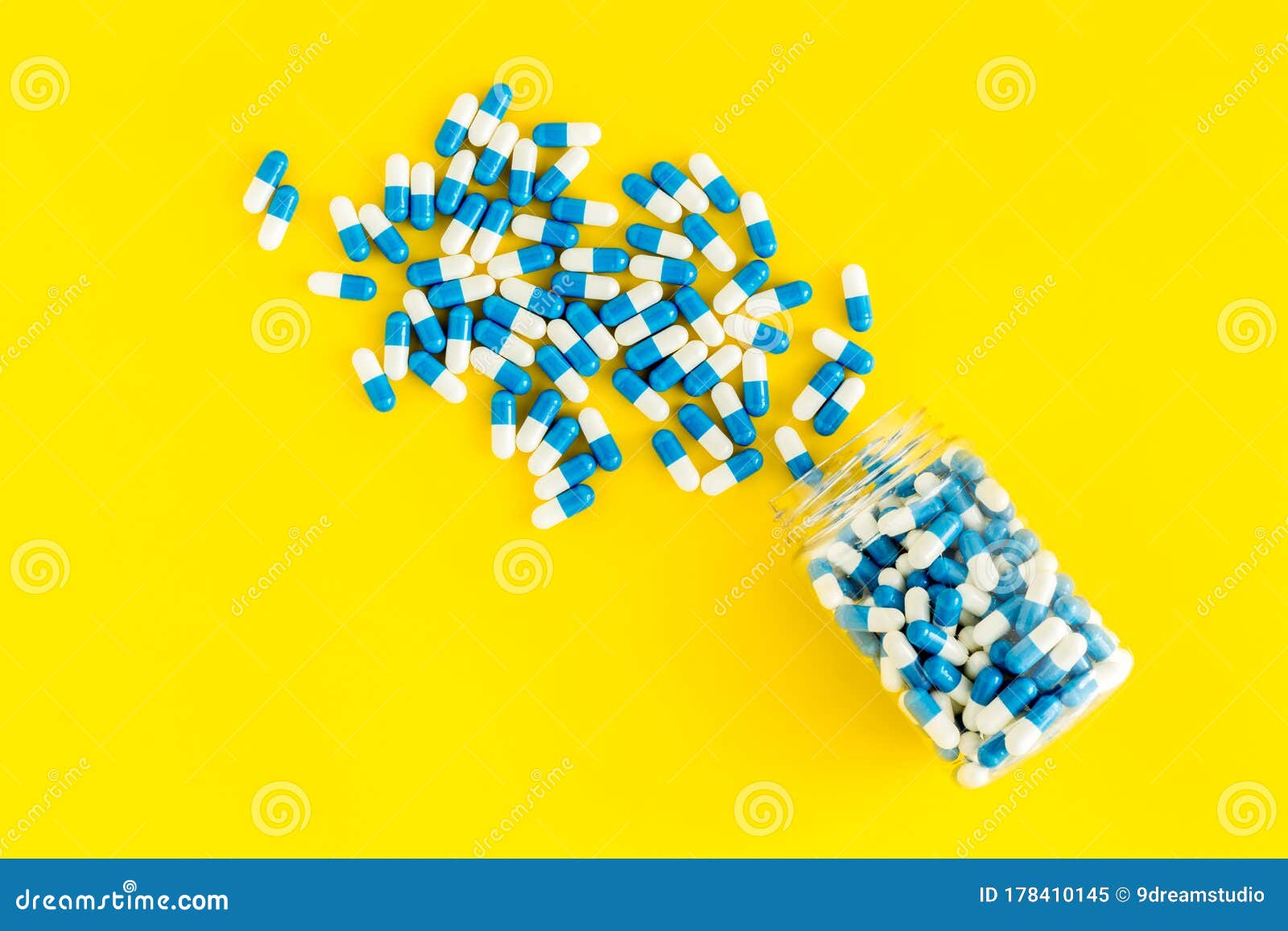Blue and White Capsules Poured from a Bottle - Sports Supplement ...