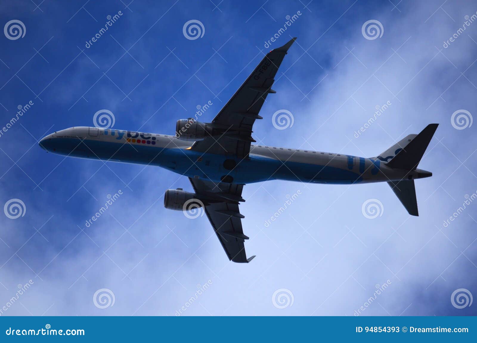 Blue and White Commercial Airplane Flying Left in Low Altitude ...