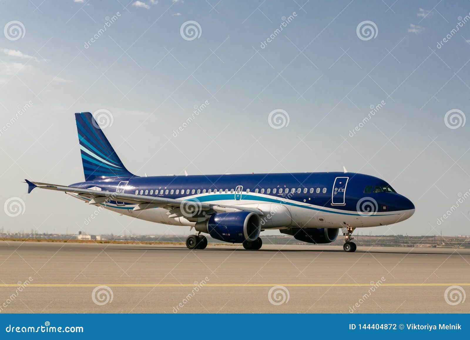 Blue and White Passenger Embraer 190 on the Runway. Stock Photo - Image ...