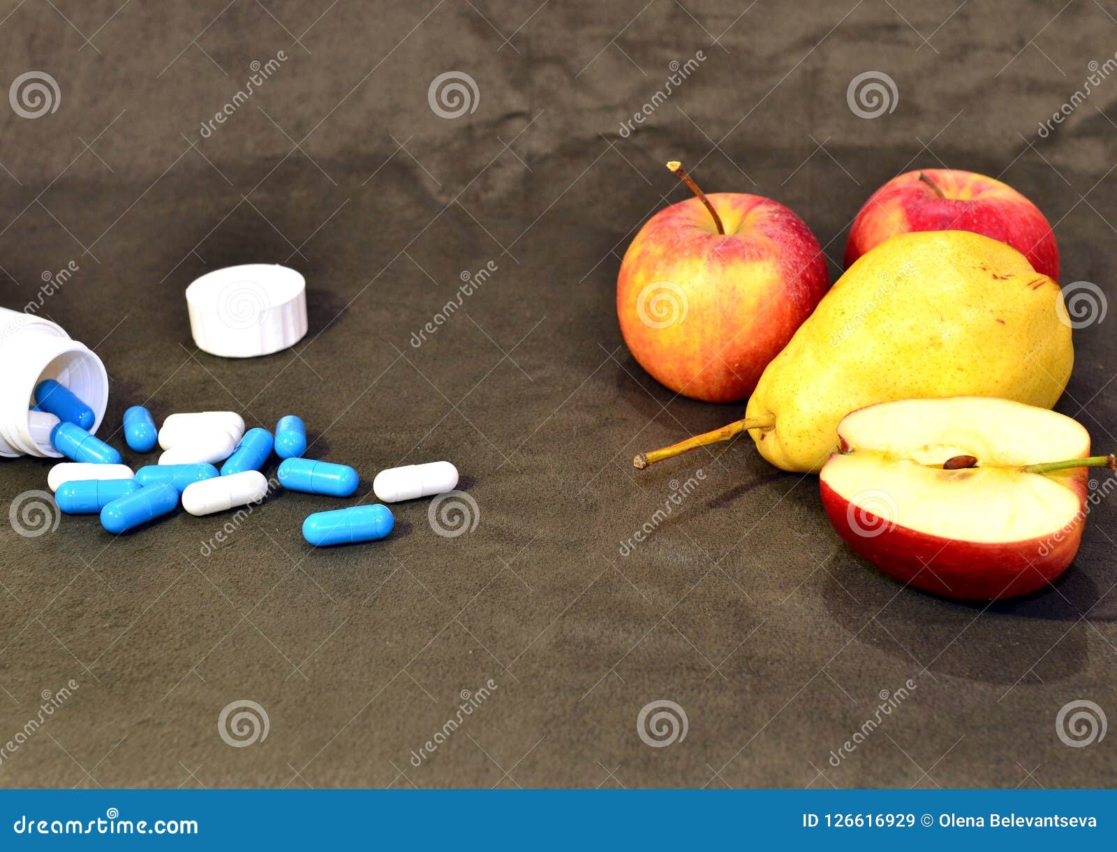 White Vitamins And Pills With Green Vegetables On Sky Blue Background ...