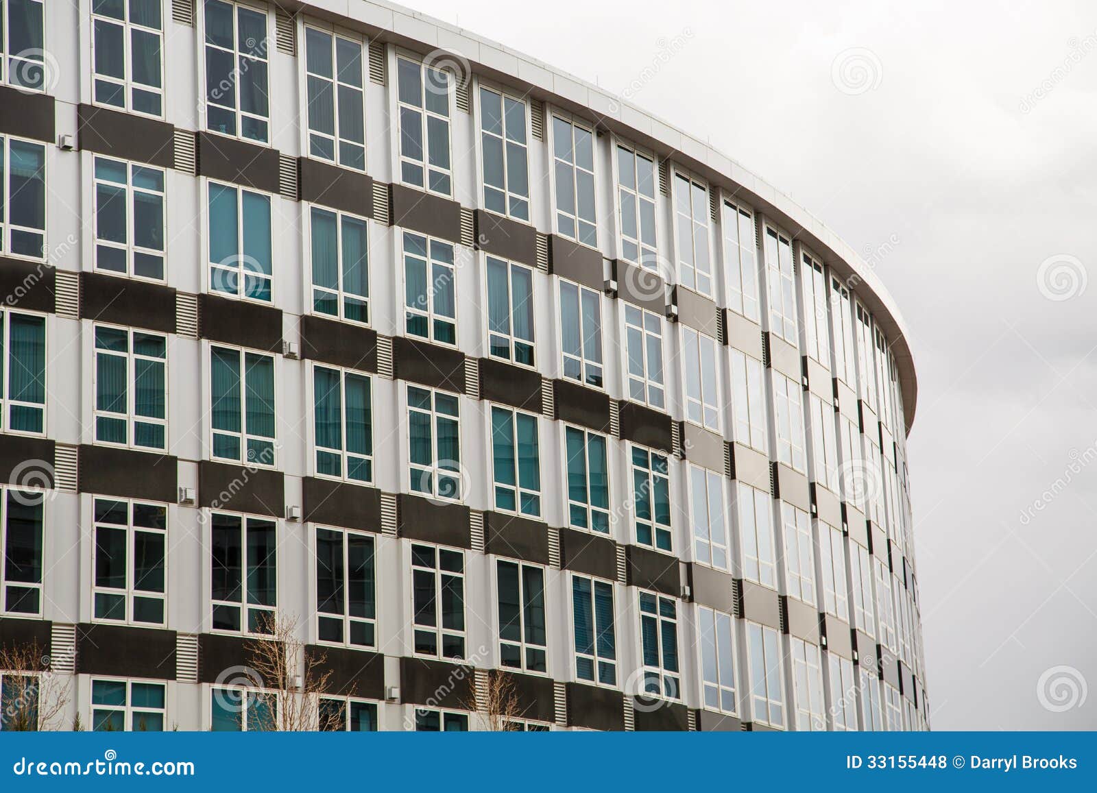 Blue Windows on Brown and Silver Curved Building Stock Photo - Image of ...