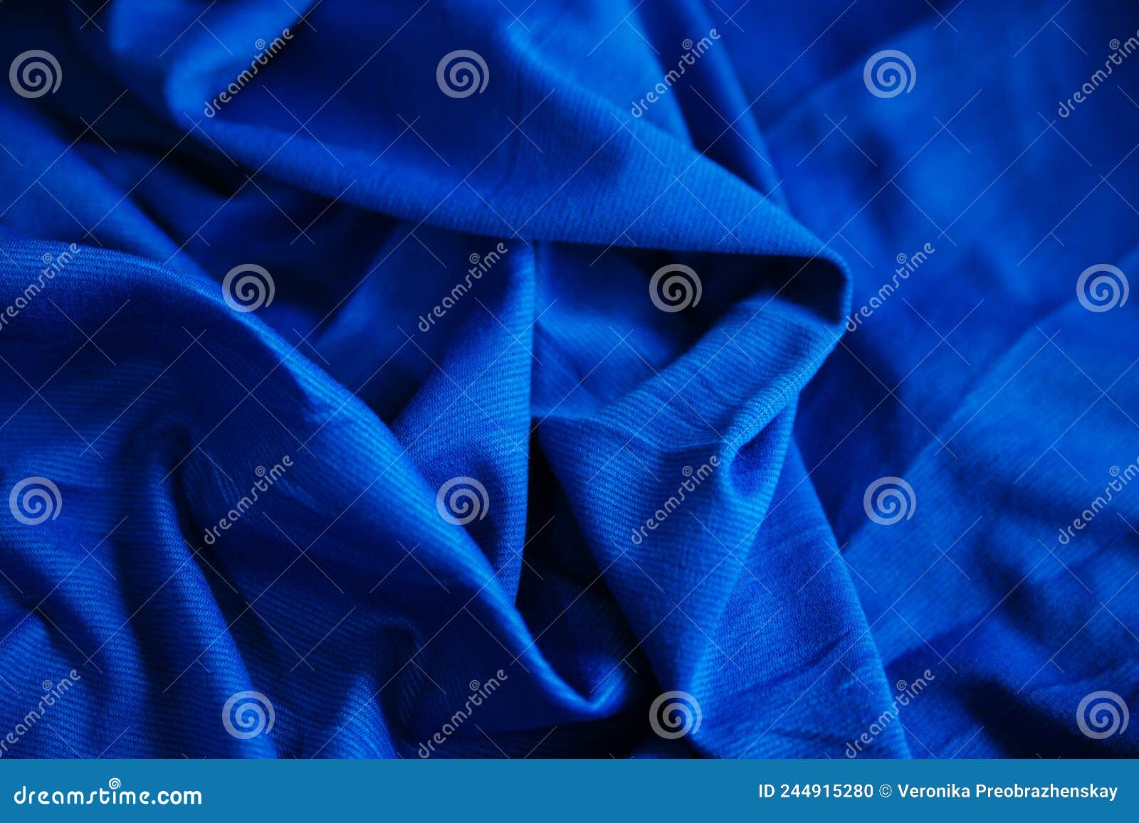 Blue Wrinkled Draped Fabric. Sewing Material is on the Table Stock ...