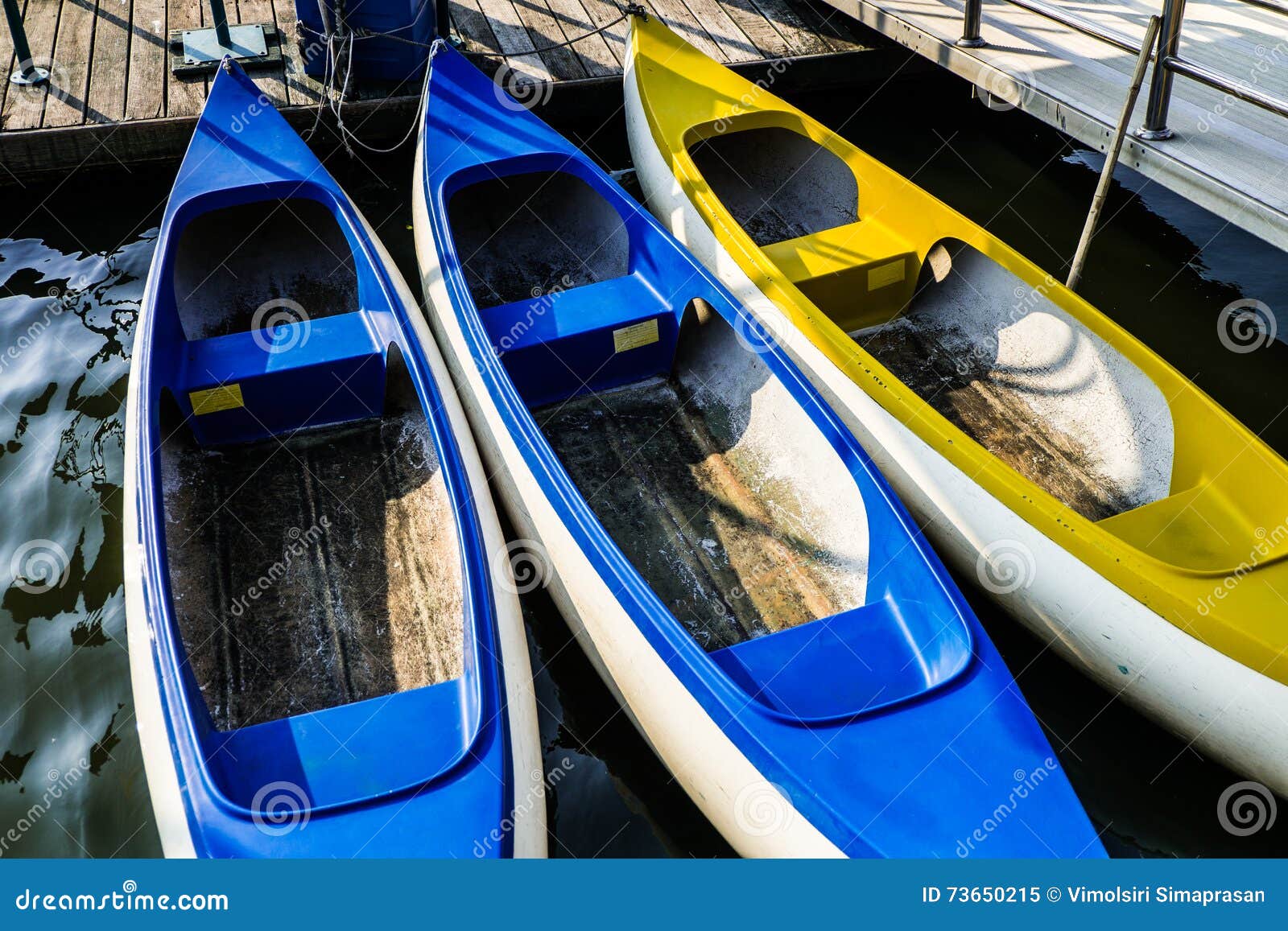 Blue and Yellow canoes stock image. Image of nautical - 73650215