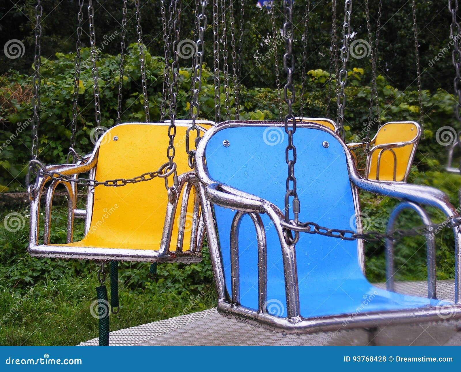 Blue and Yellow Swings in Rain Stock Photo - Image of solid, childhood ...