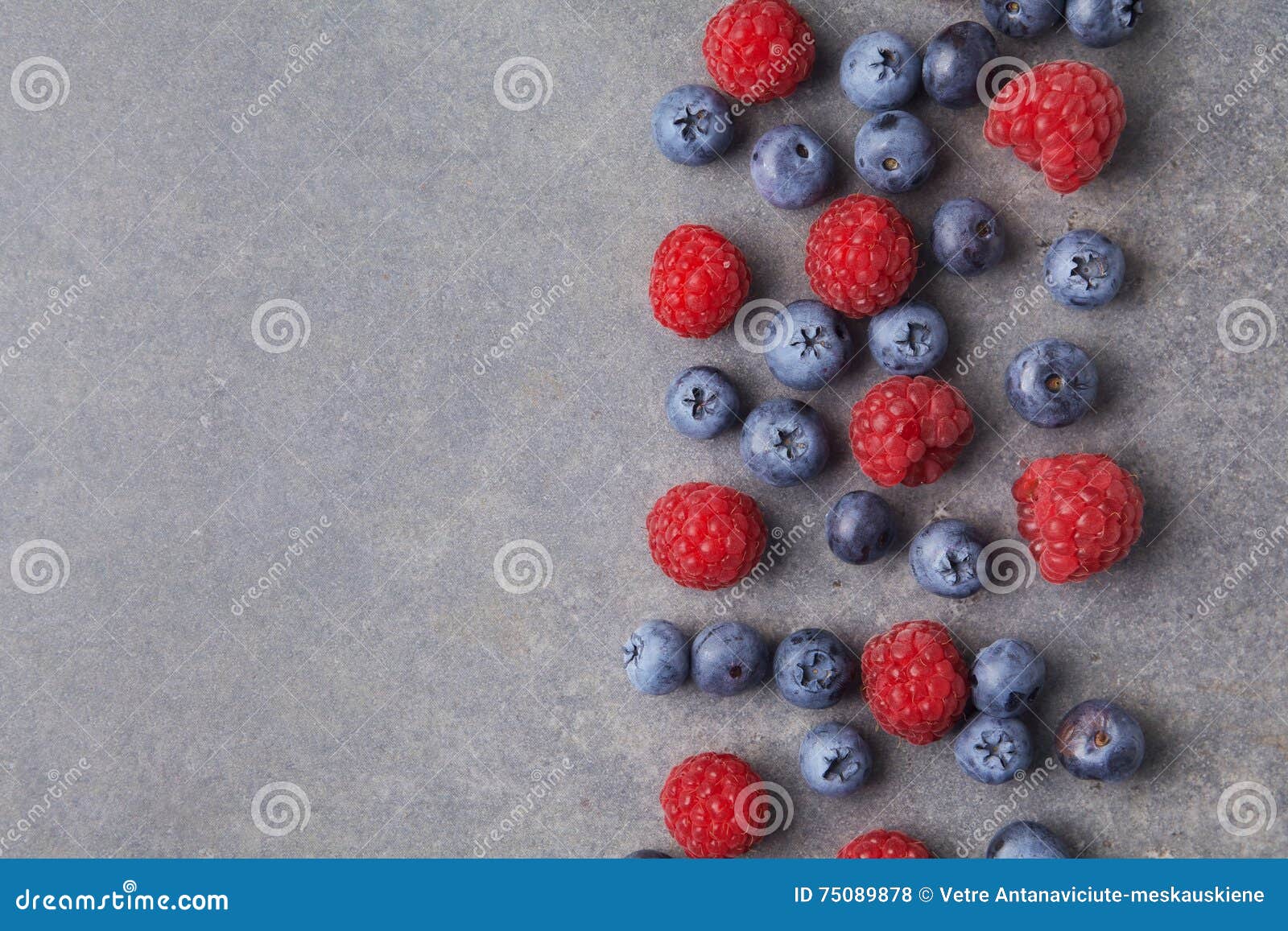 Blueberries and Raspberries in a Bowl on Rusty Grey Background. Top ...