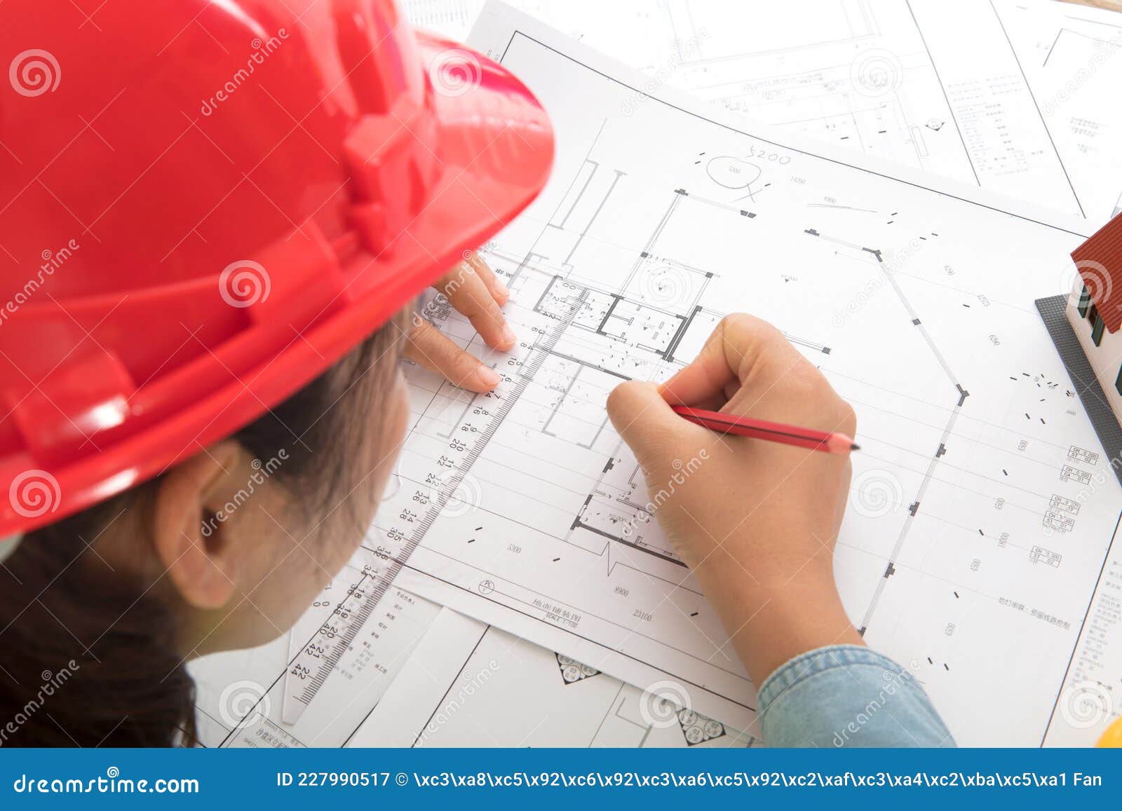 Blueprint Designer Wearing Red Hard Hat at Work Stock Image - Image of ...